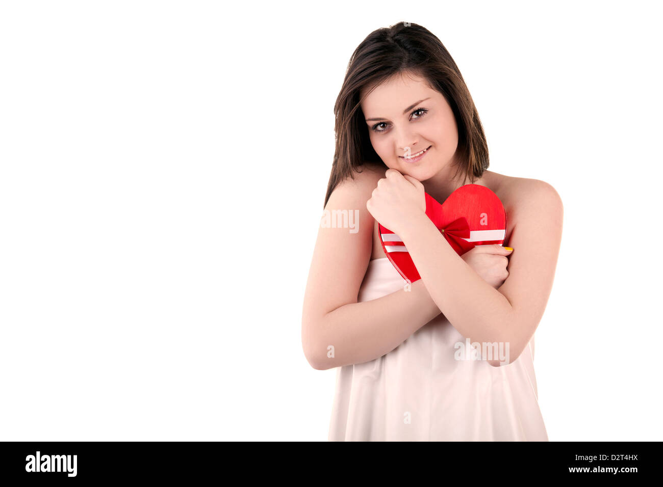 Gorgeous girl with a heart in her hands isolated on white studio shot ...