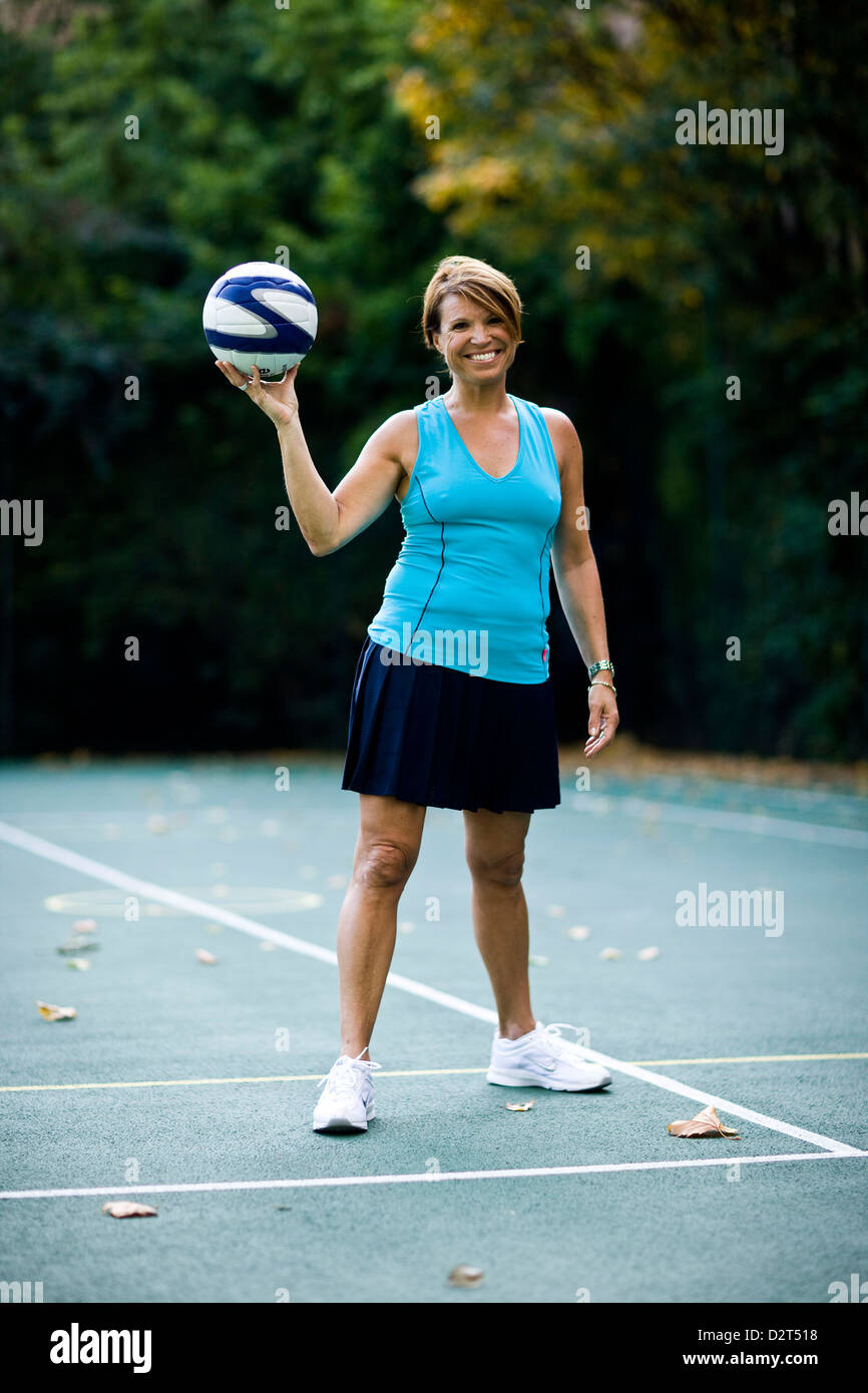 Netball player holding ball, portrait Stock Photo - Alamy