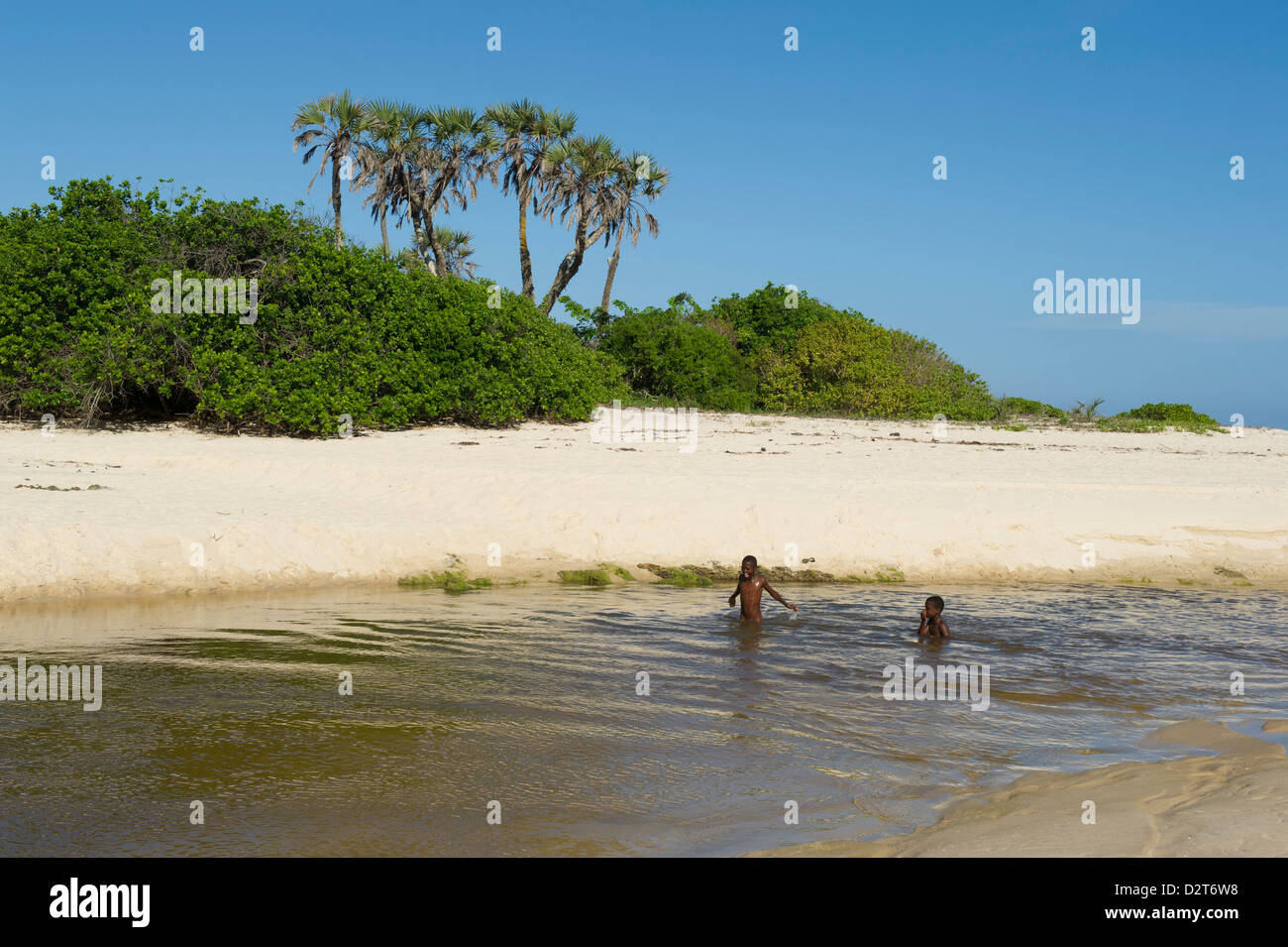 Children swimming in the mouth of the Mwachema River, Diani Beach ...