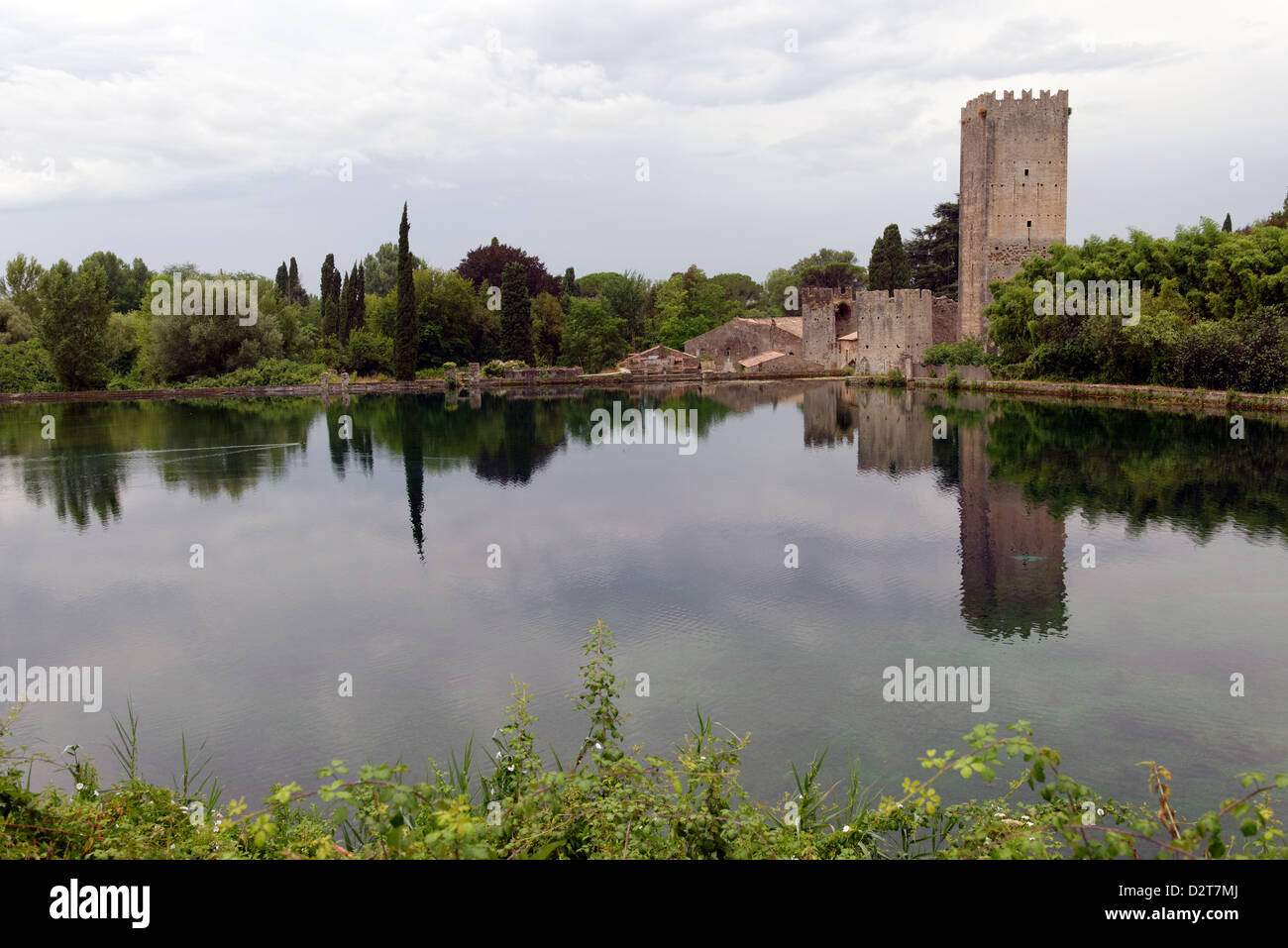 The medieval castle tower and lake at the beautiful and romantic Garden ...
