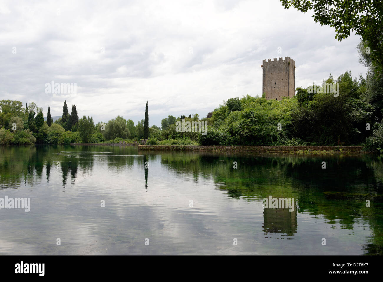 The medieval castle tower and lake at the beautiful and romantic Garden ...
