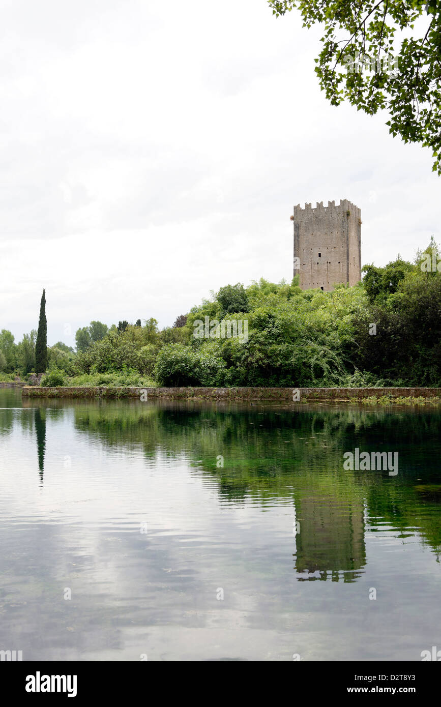 The medieval castle tower and lake at the beautiful and romantic Garden ...