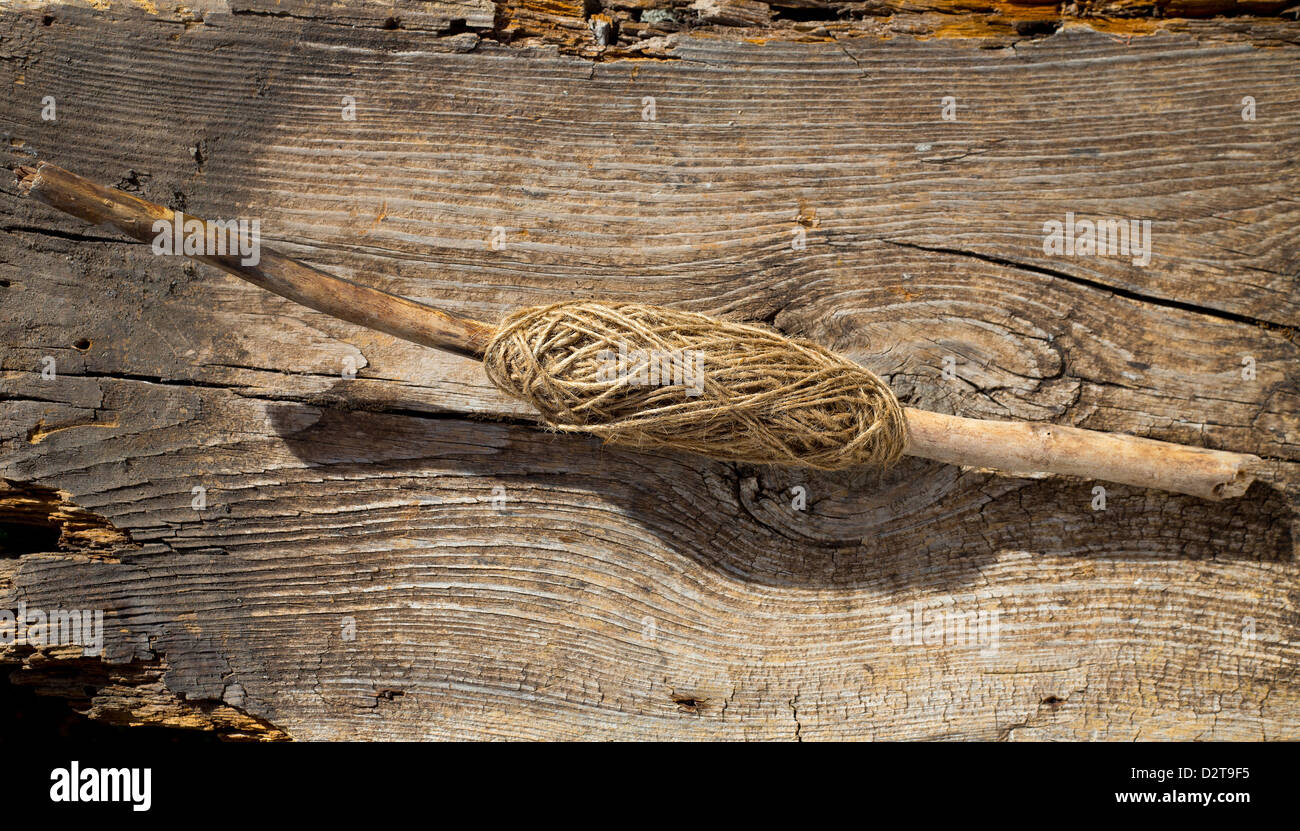 Traditional thread spool on tree stick branch over aged wood Stock ...
