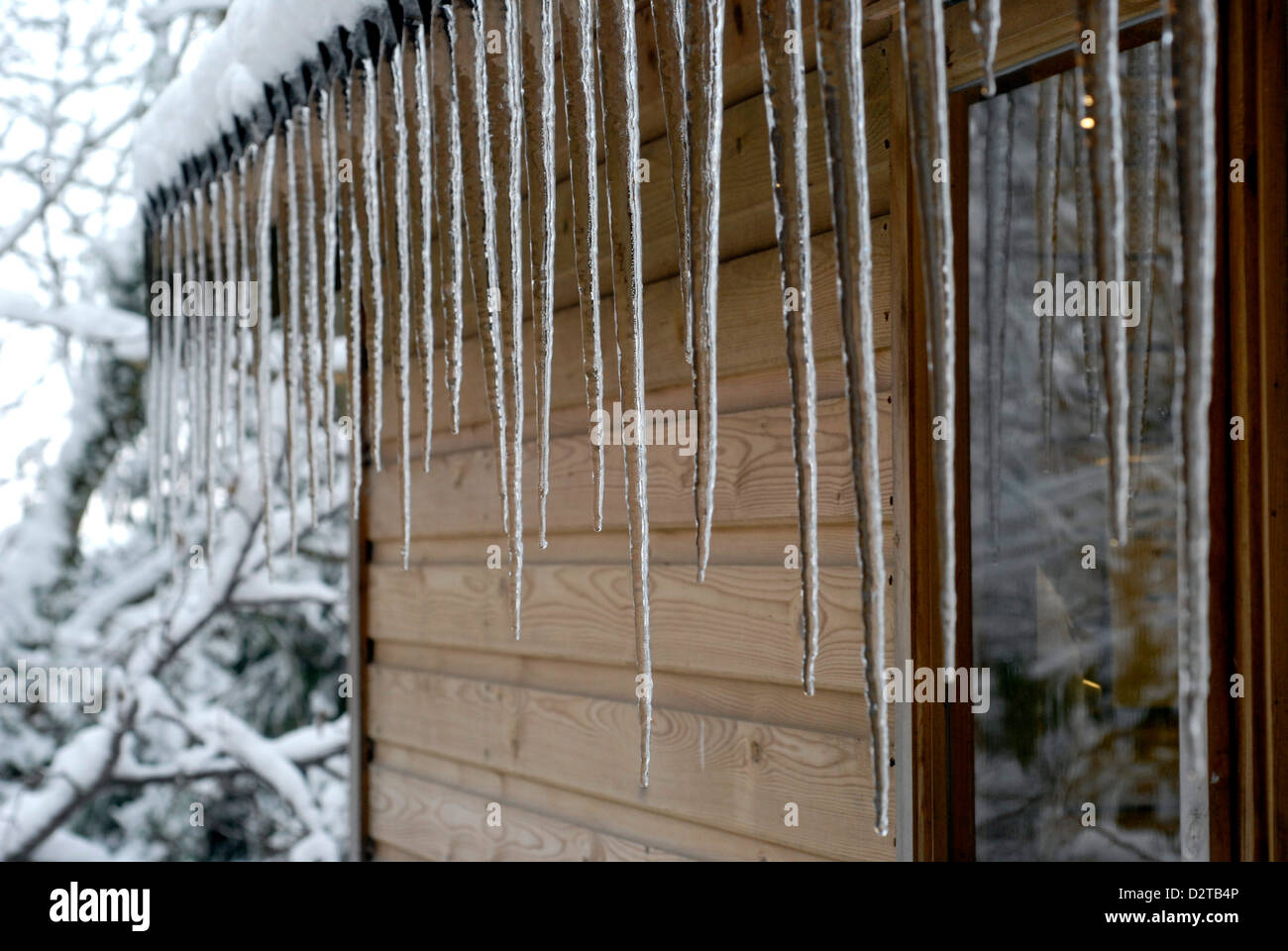 Frozen icicles suspended from a window frame in winter.UK Stock Photo ...