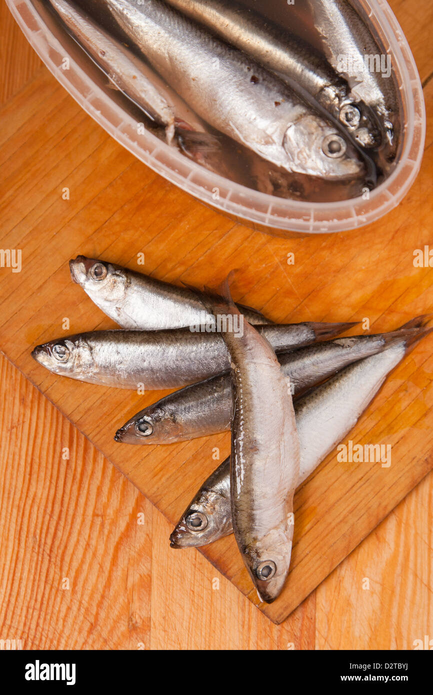 salted anchovies in box on wooden background Stock Photo - Alamy