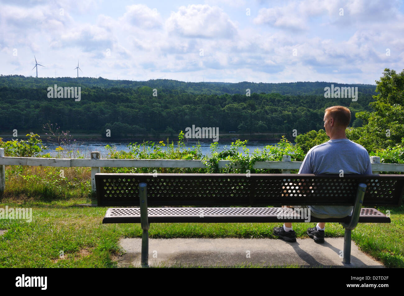 Man relaxing on a bench overlooking the Cape Cod Canal, Massachusetts ...