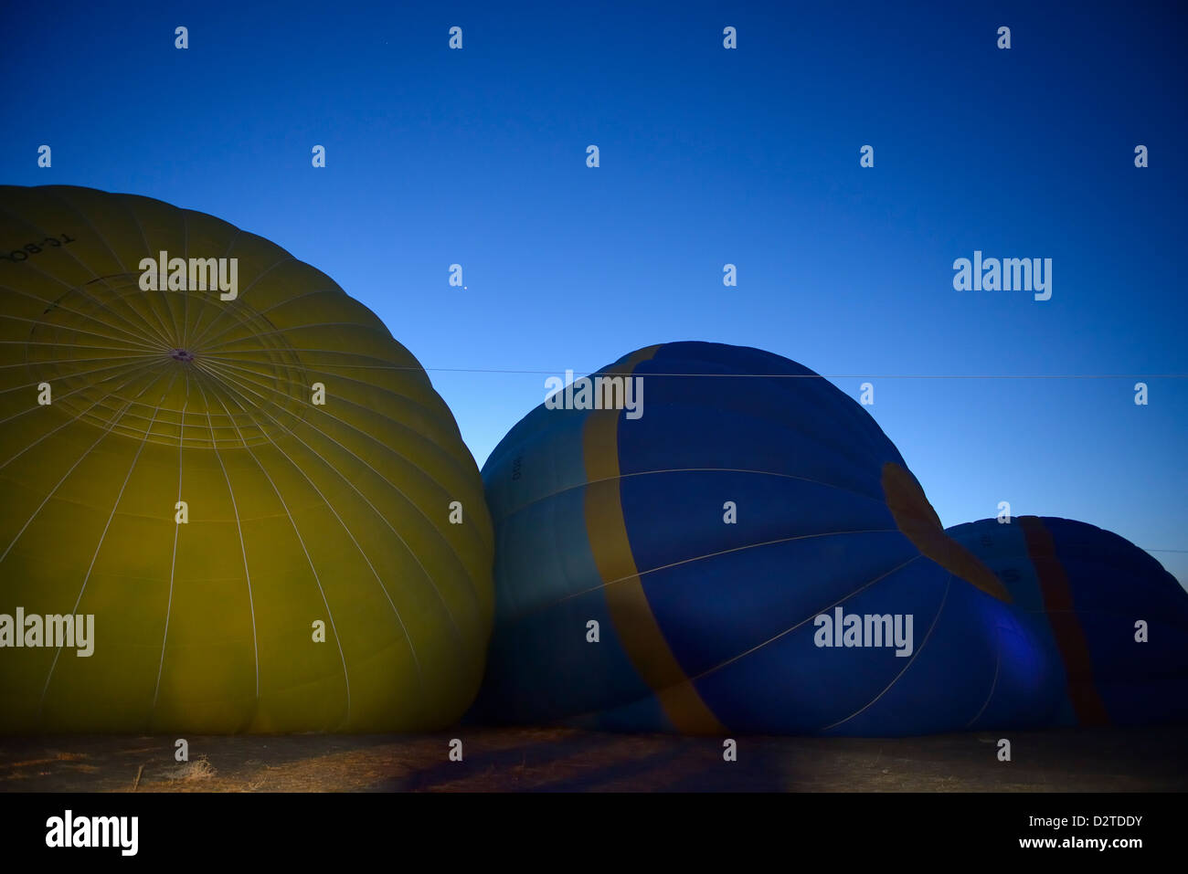 Venus rising at twilight over hot air balloons being inflated in ...