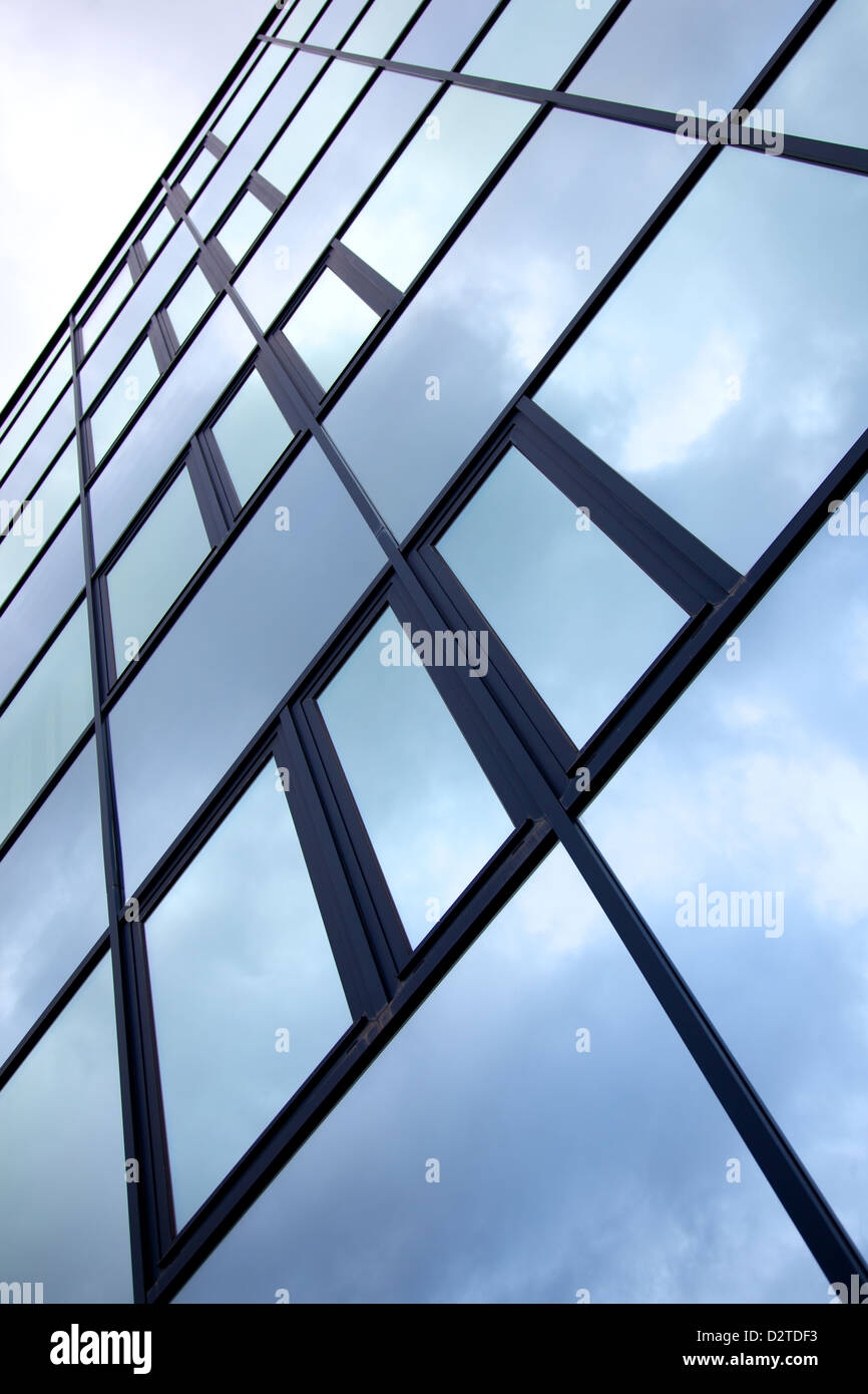 facade of office building with overcast sky reflected Stock Photo - Alamy