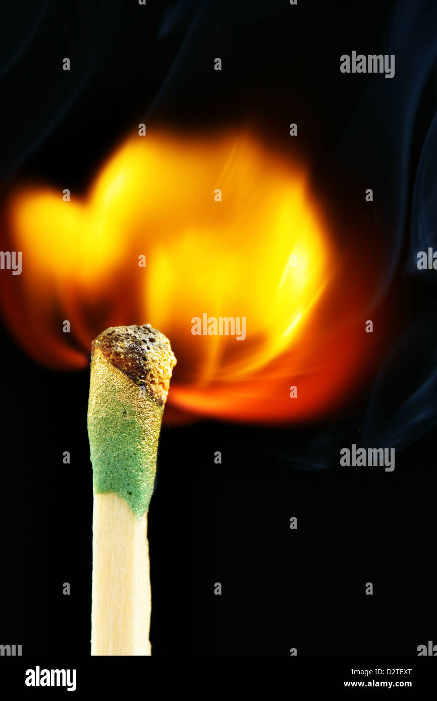 Burning match close-up over black background Stock Photo - Alamy