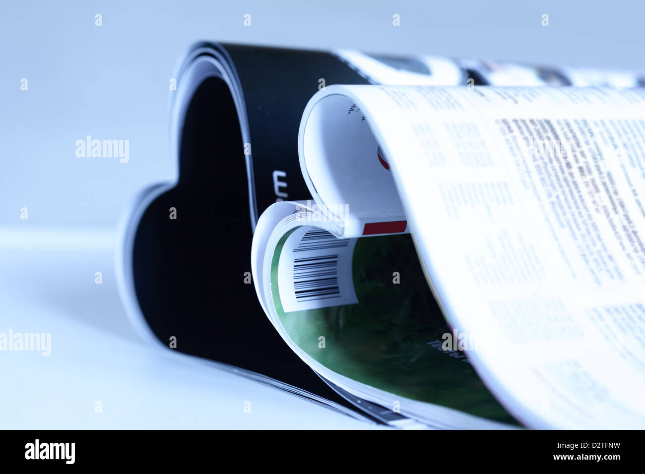 Two magazines folded to heart shape on table Stock Photo - Alamy