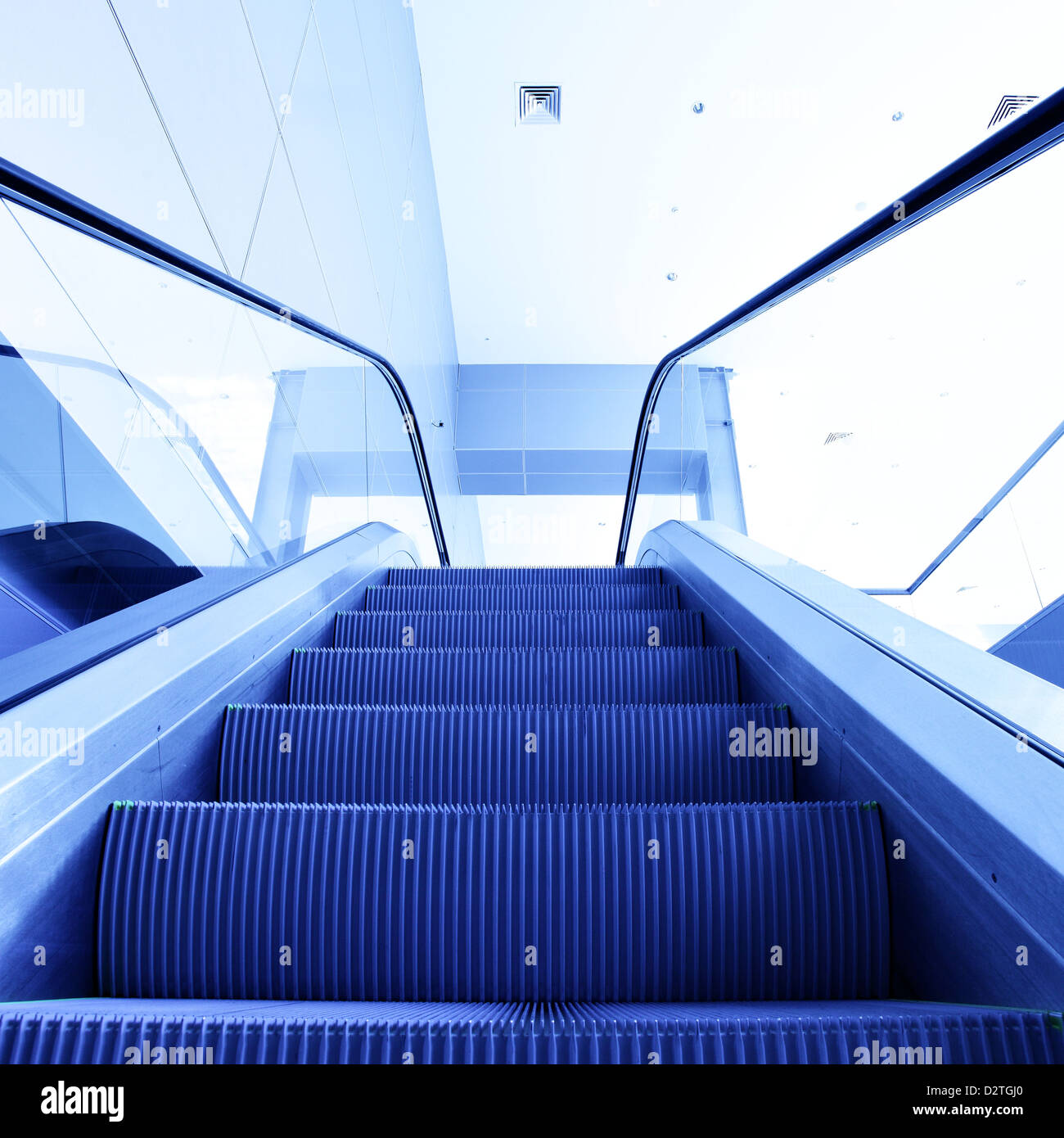 Perspective of escalator toned in blue color Stock Photo - Alamy