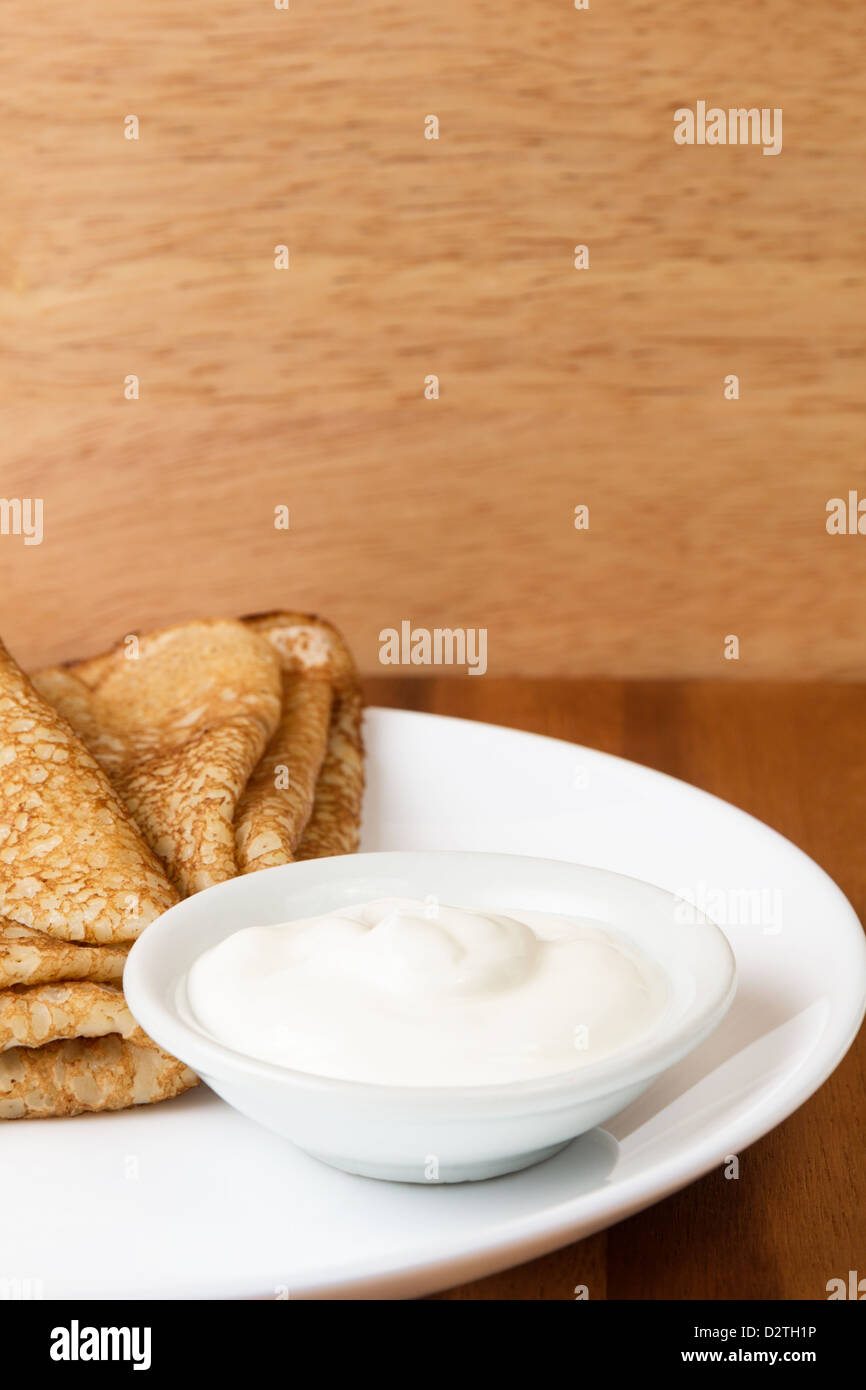 russian crepes with sour cream, on plate Stock Photo - Alamy