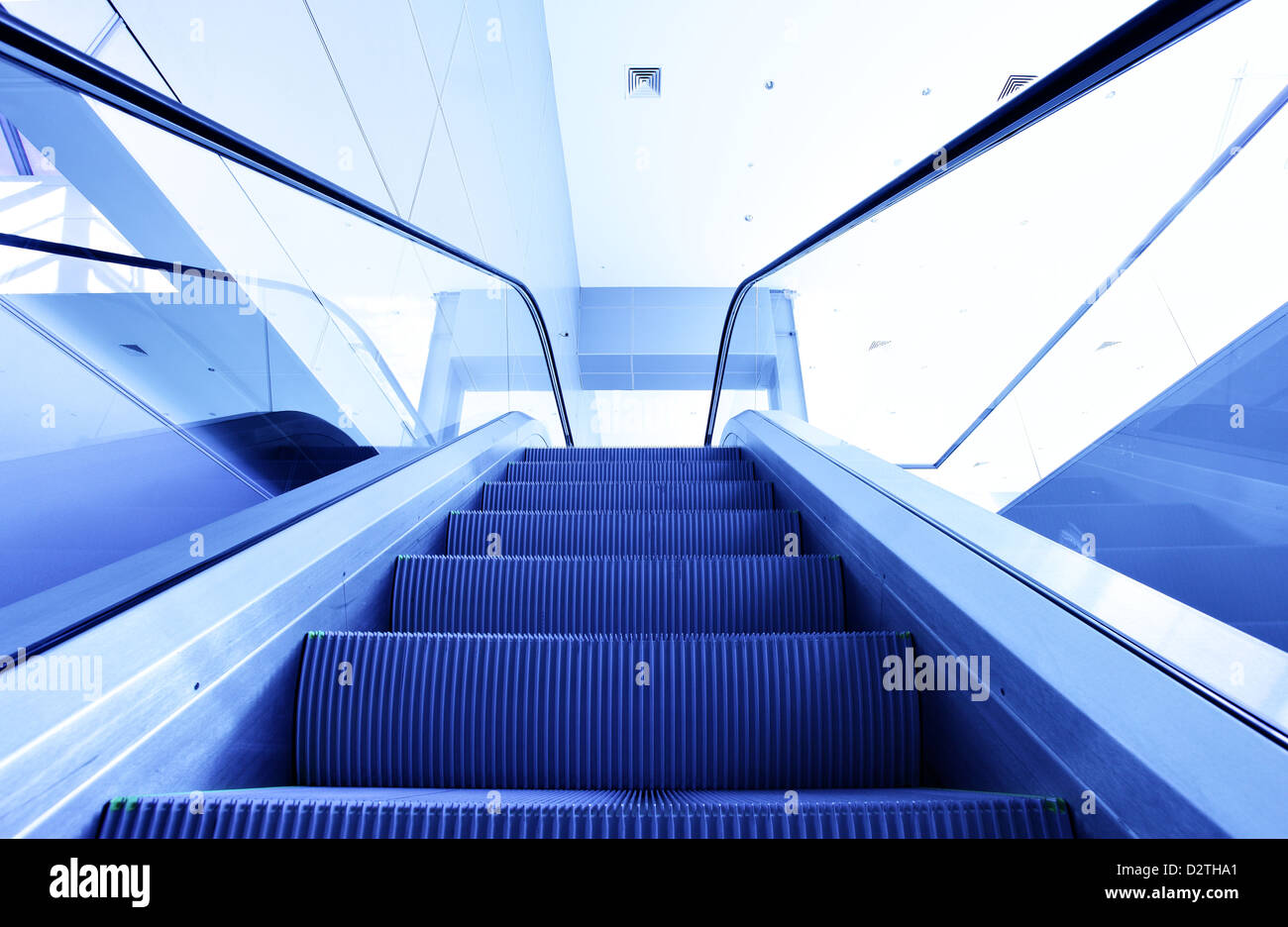 Perspective of escalator toned in blue color Stock Photo - Alamy