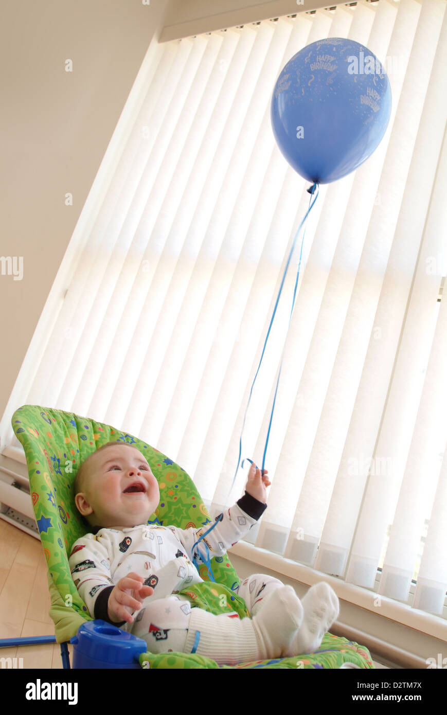 Baby with a blue baloon Stock Photo - Alamy