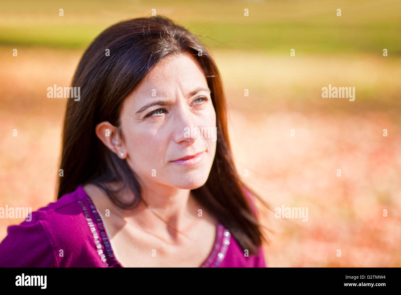 Sad beautiful woman outdoors against fall leaf background Stock Photo ...