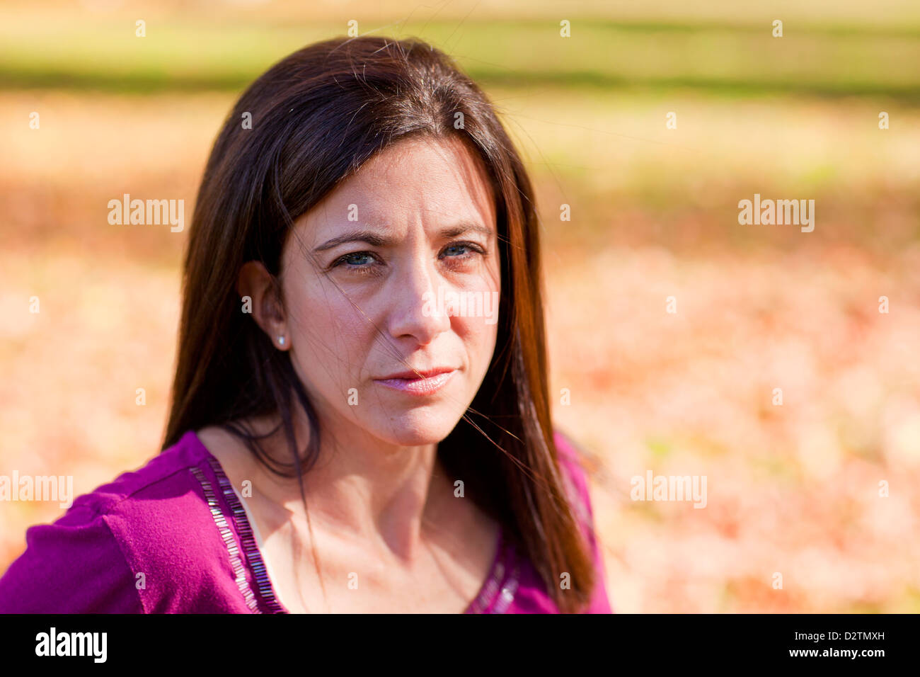 Sad beautiful woman outdoors against fall leaf background Stock Photo ...