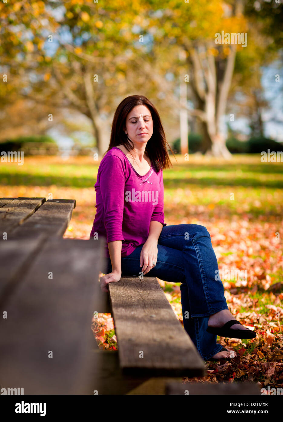 Sad beautiful woman outdoors against fall leaf background Stock Photo ...