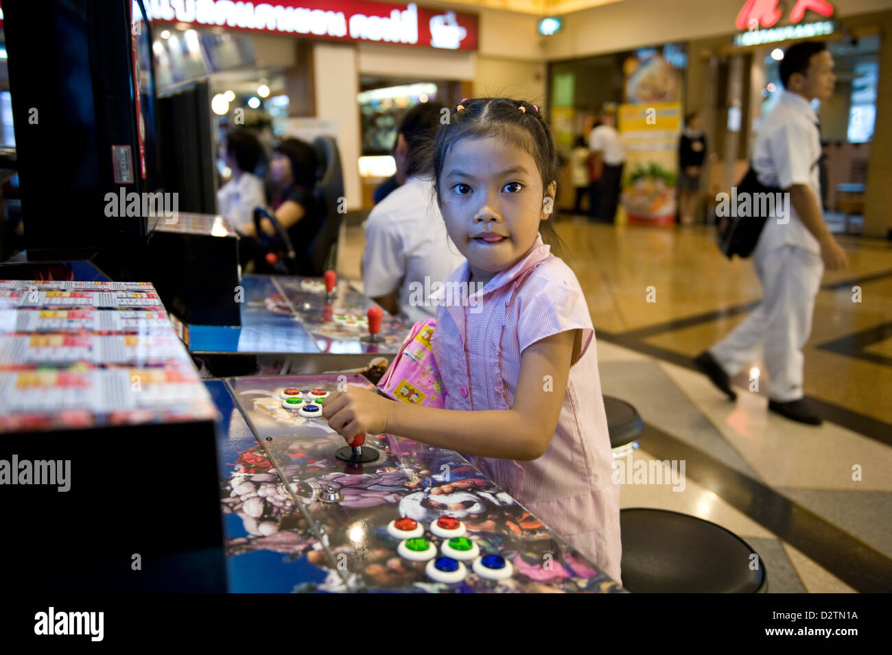 Bangkok, Thailand, a little girl playing on a slot machine Stock Photo ...