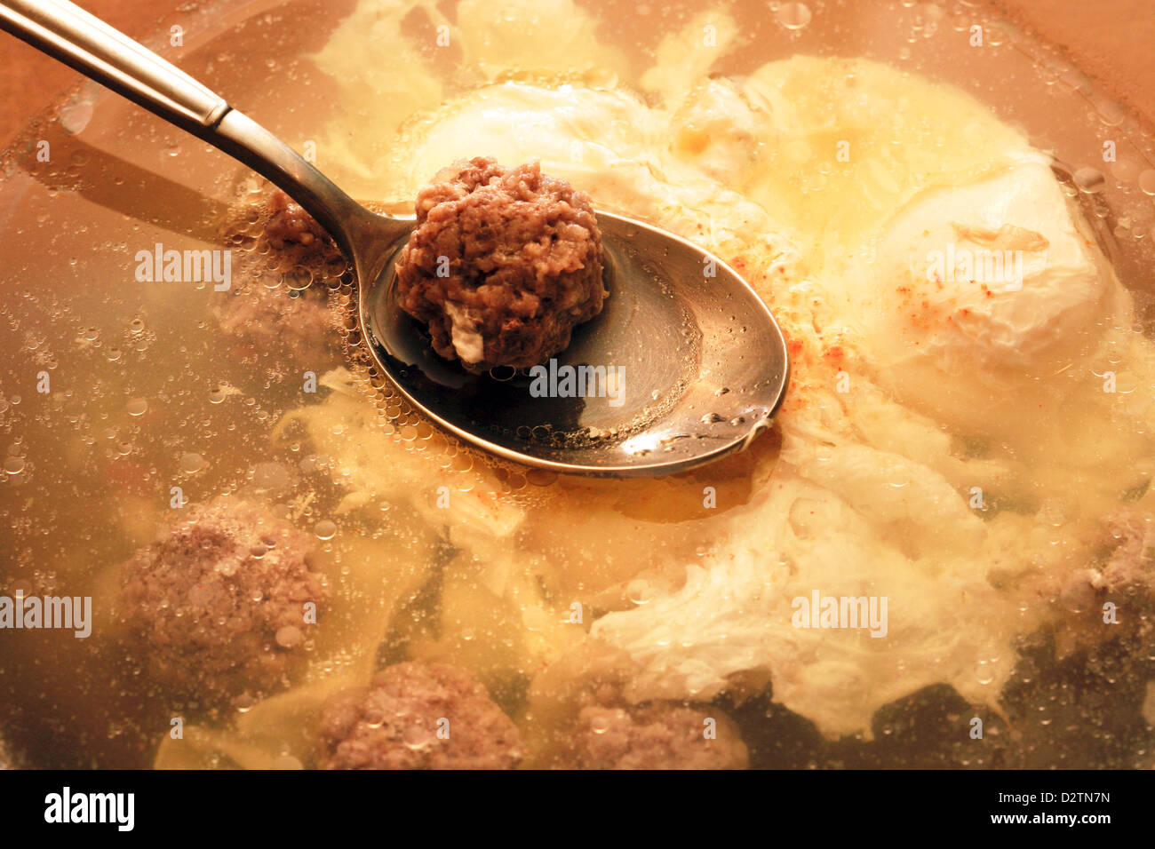 Transparent broth with egg and meat balls Stock Photo - Alamy