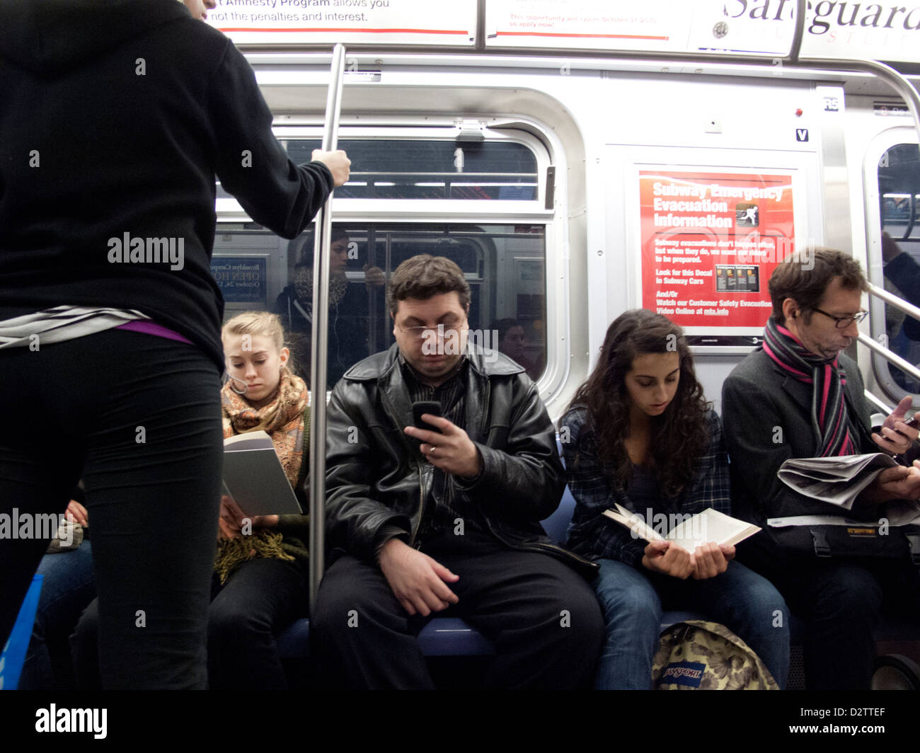 people reading on the subway Stock Photo - Alamy
