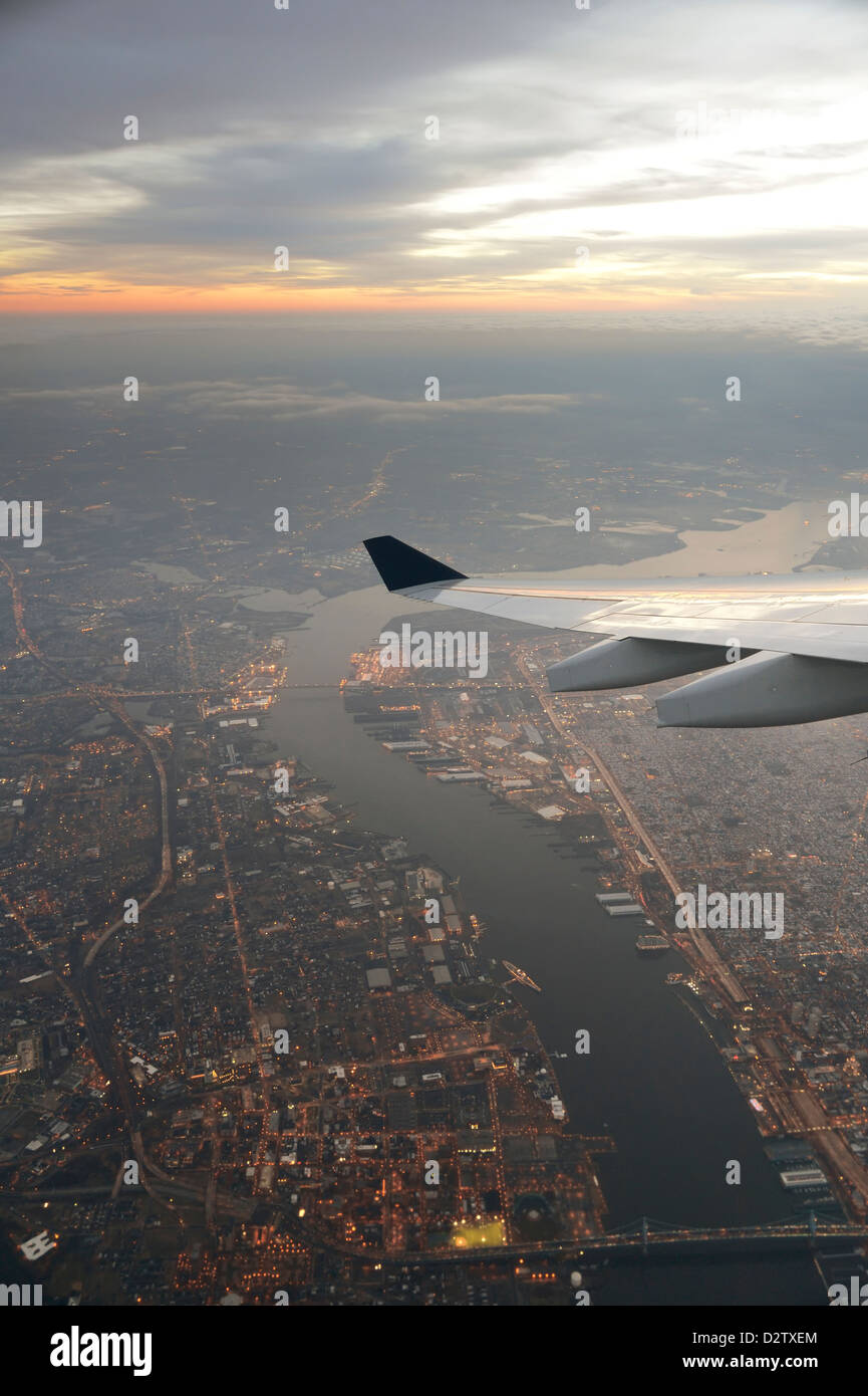 Airplane Wing & Sunset Clouds, City Lights Below Stock Photo - Alamy