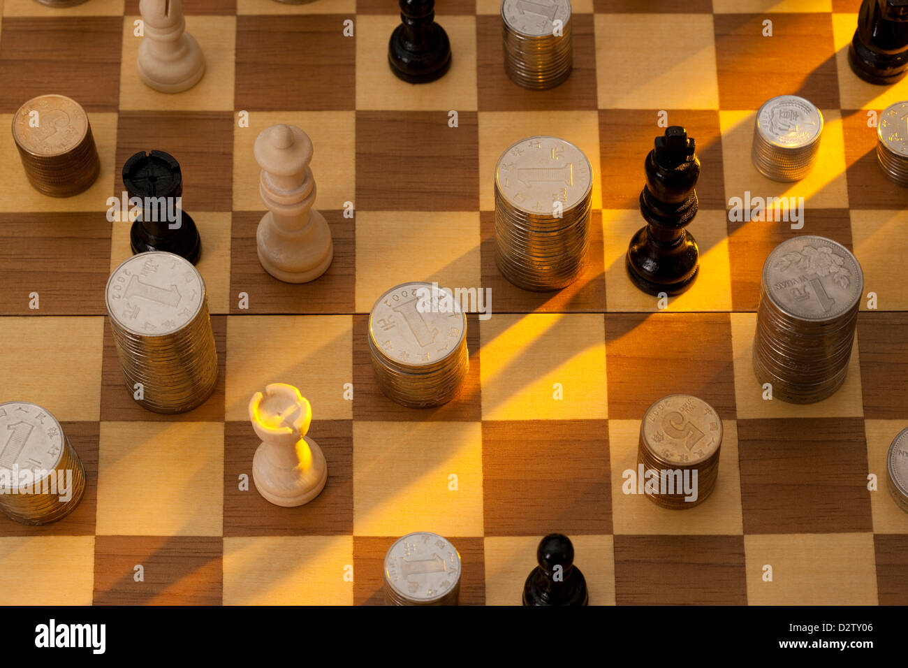 Coins and chess pieces on chess board Stock Photo - Alamy