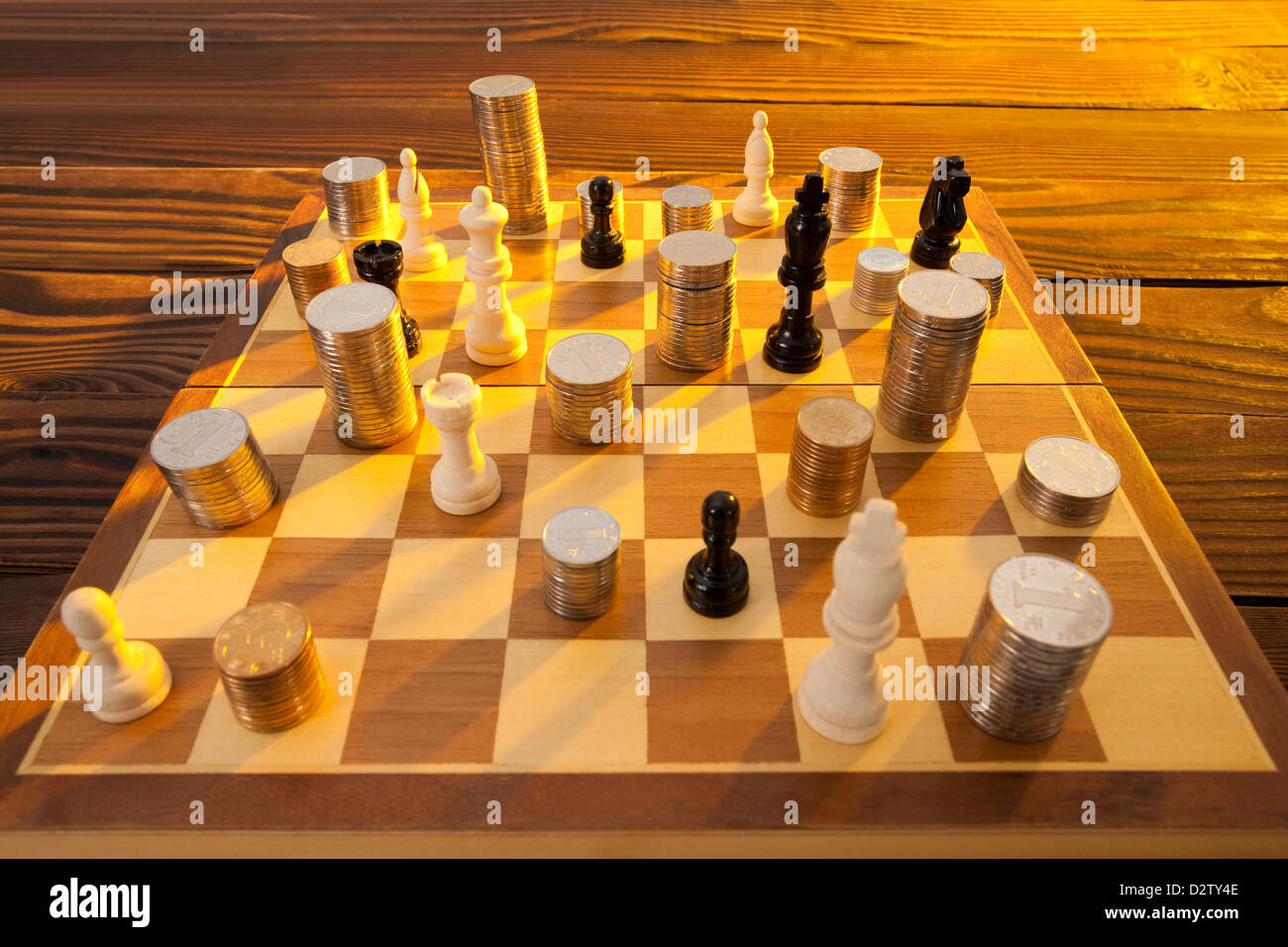 Coins and chess pieces on chess board Stock Photo - Alamy