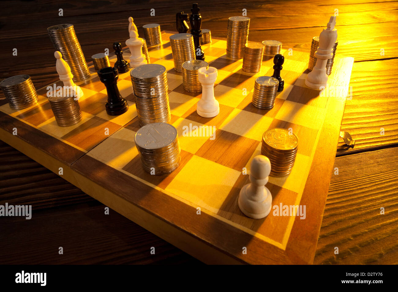 Coins and chess pieces on chess board Stock Photo - Alamy