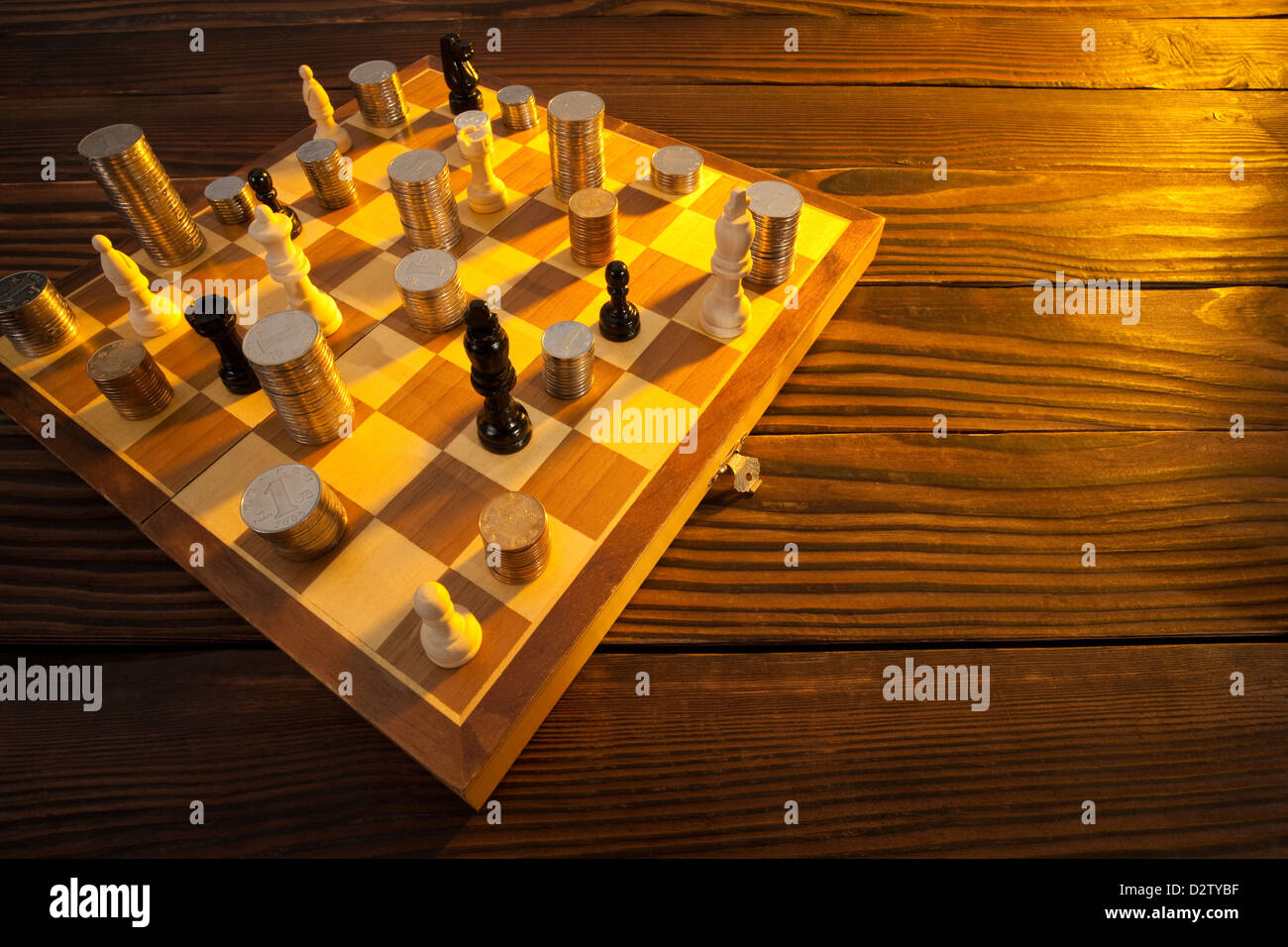 Coins and chess pieces on chess board Stock Photo - Alamy