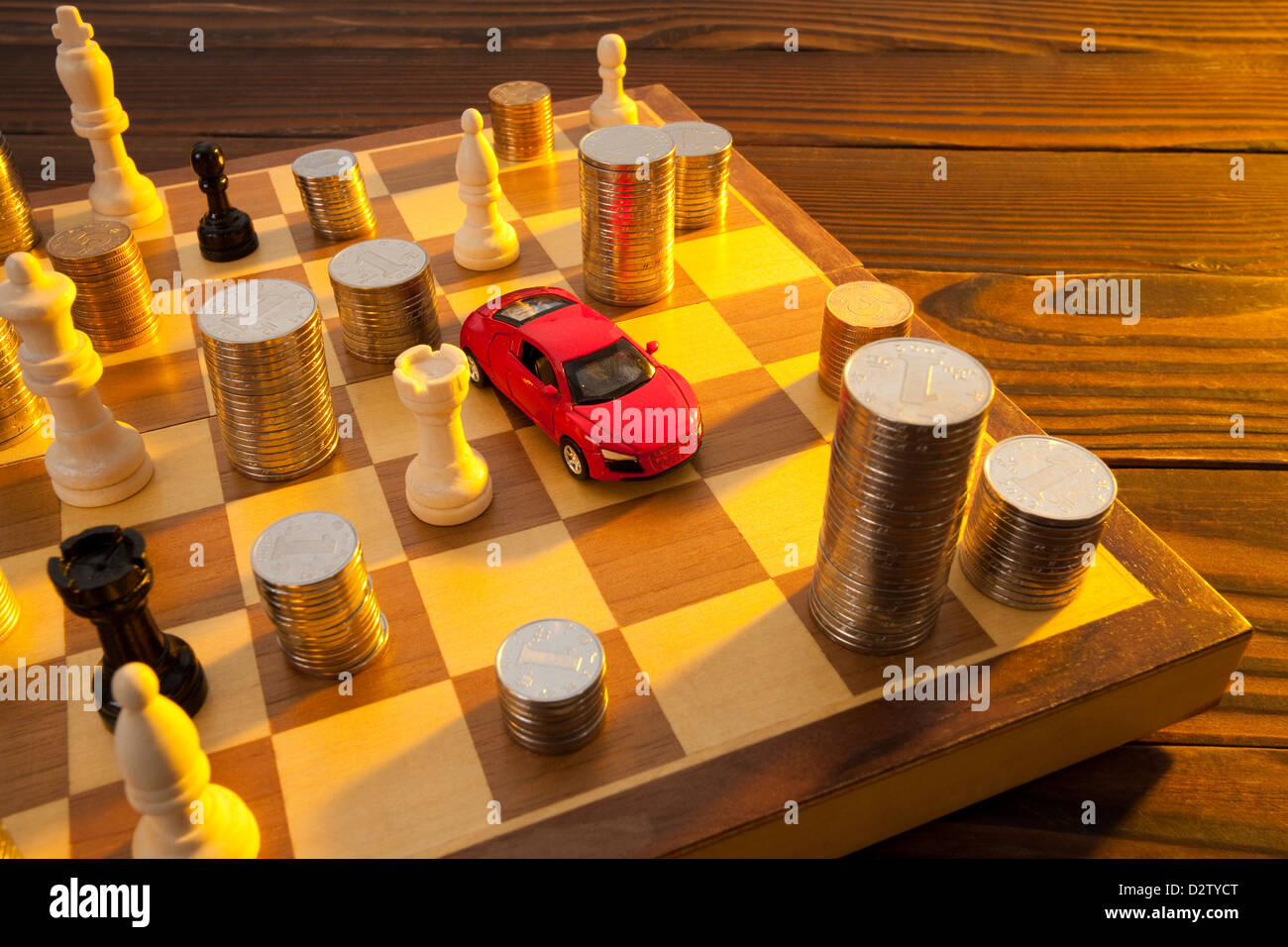 Coins, model car and chess pieces on chess board Stock Photo - Alamy