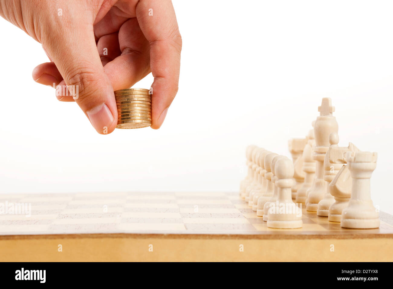 Holding coins as chess piece while playing chess Stock Photo - Alamy