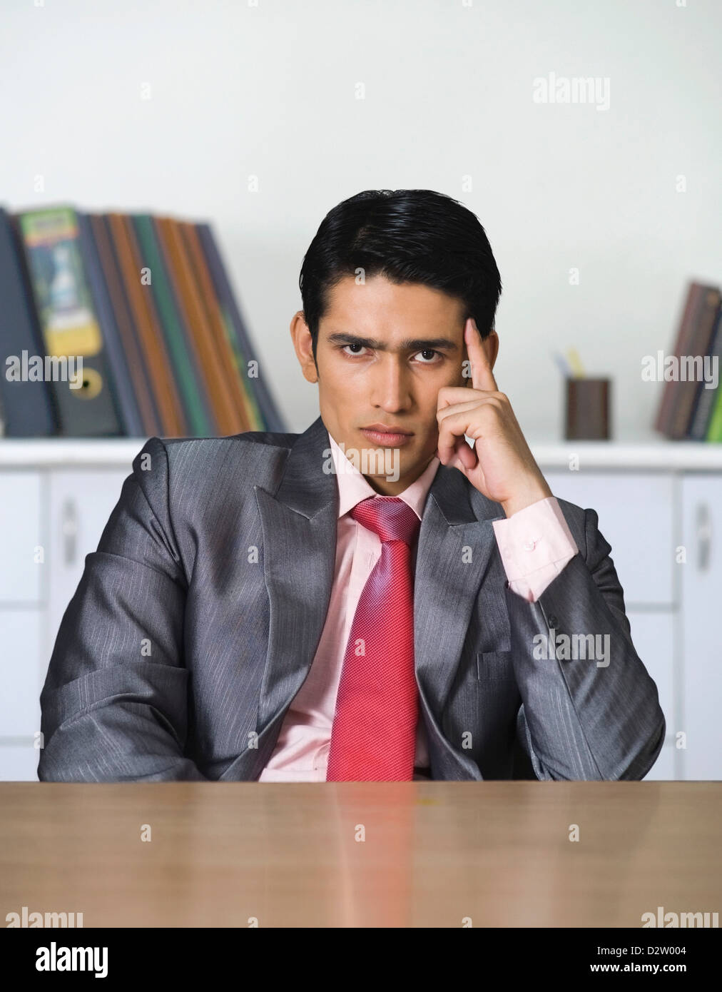Portrait of a businessman thinking Stock Photo - Alamy