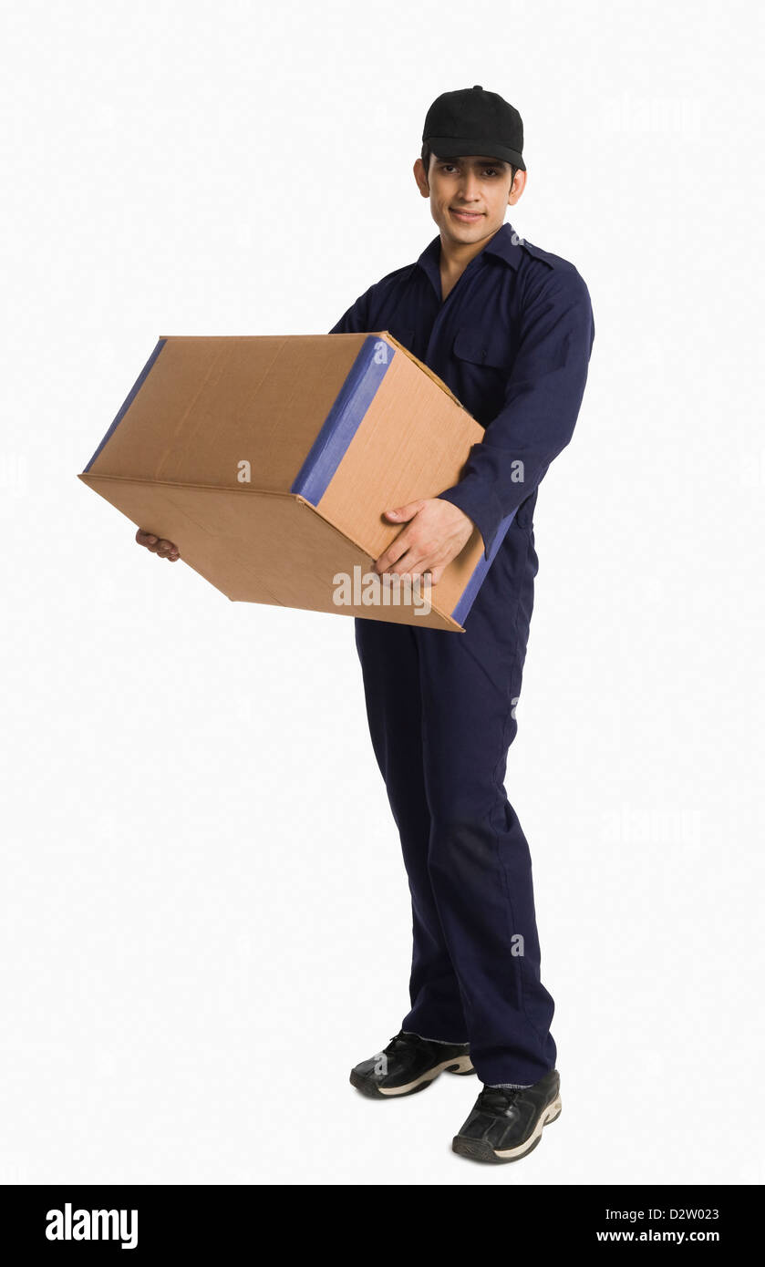 Delivery man holding a cardboard box Stock Photo - Alamy