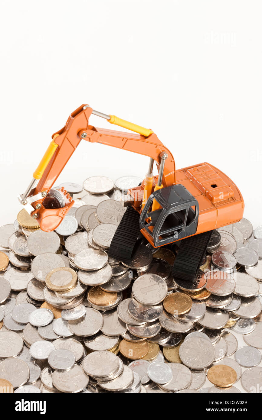 Excavator model and coins Stock Photo - Alamy