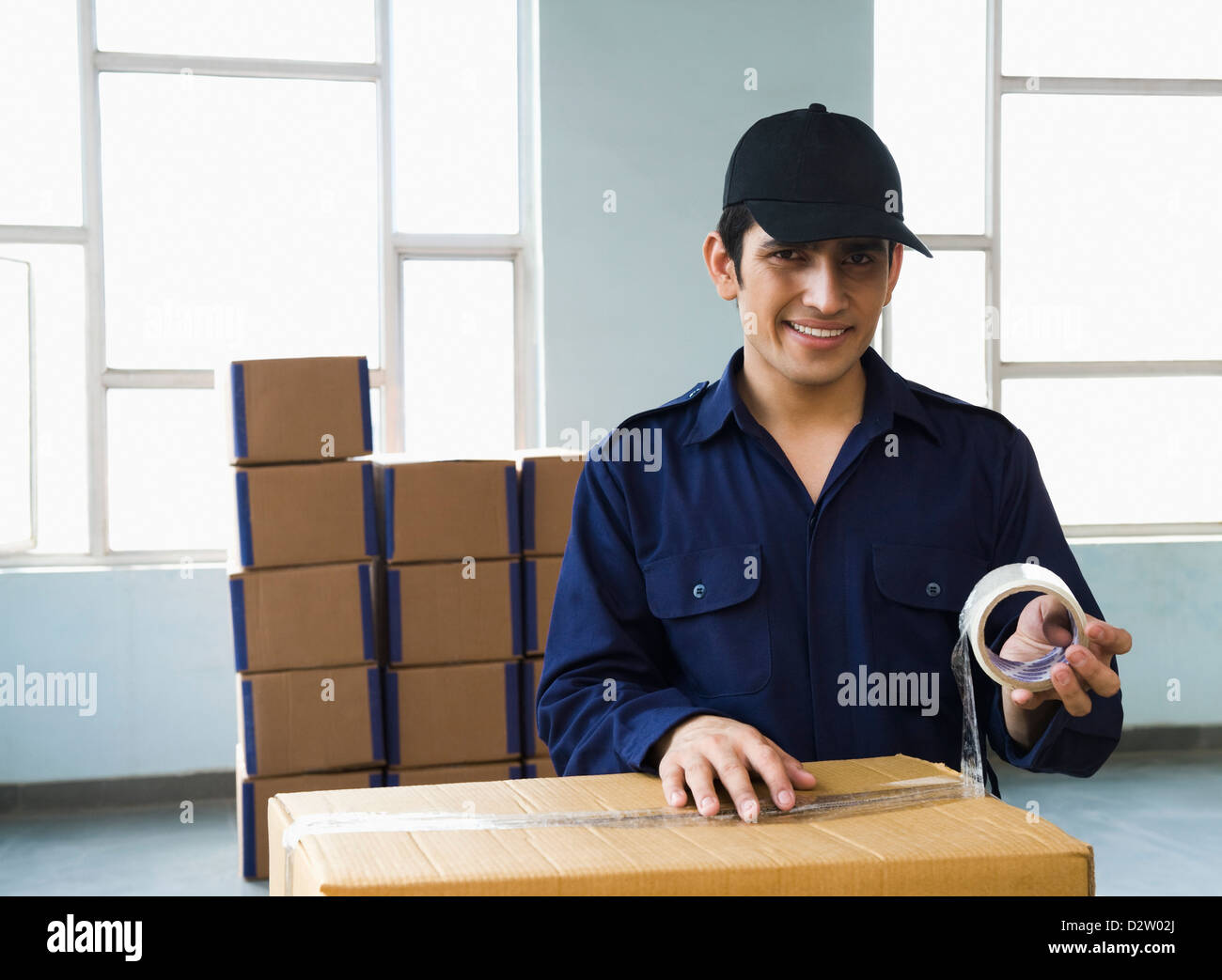 Young worker packing cardboard hi-res stock photography and images - Alamy