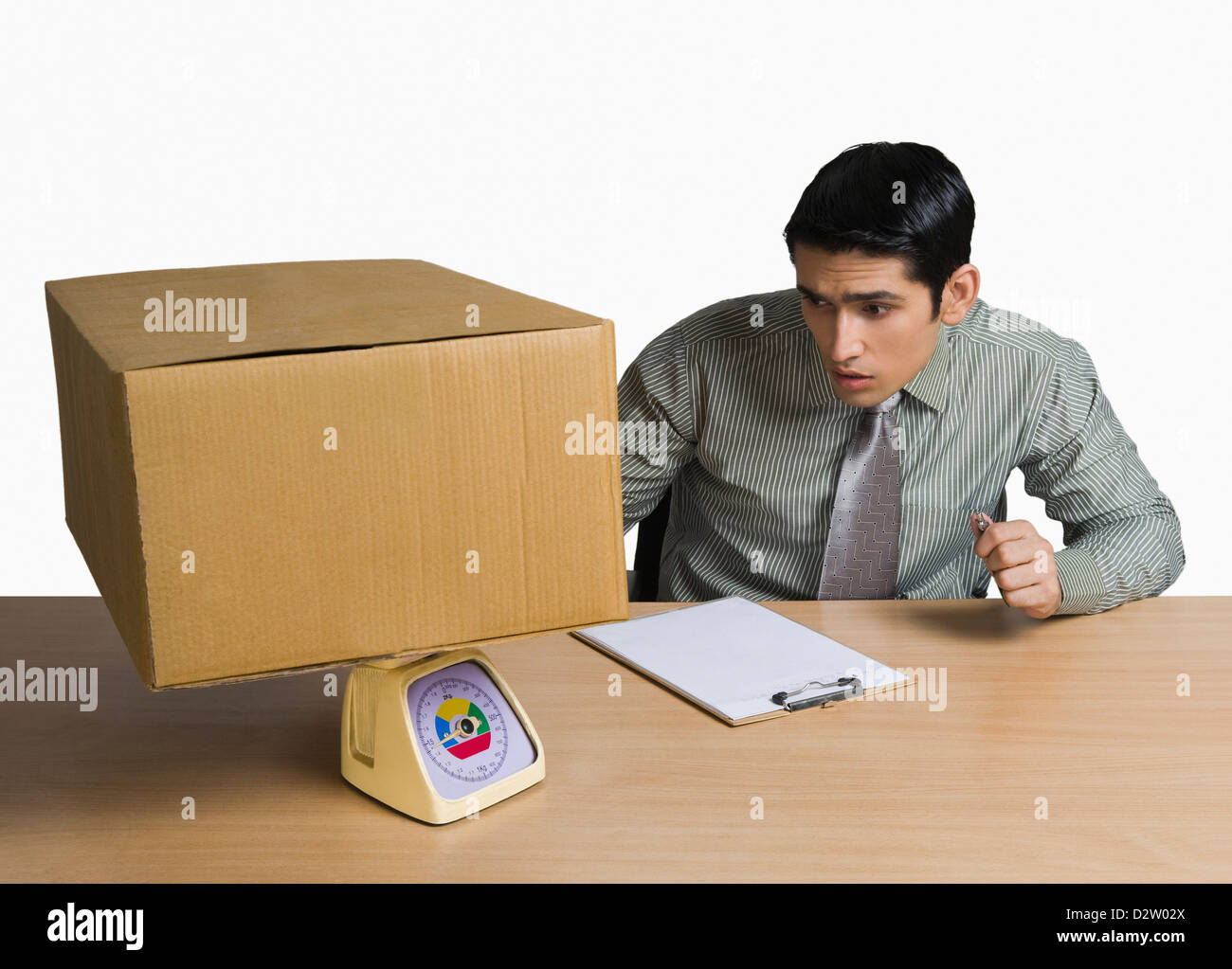 Man weighing a cardboard box and recording data Stock Photo - Alamy