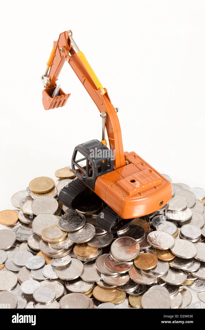 Excavator model and coins Stock Photo - Alamy