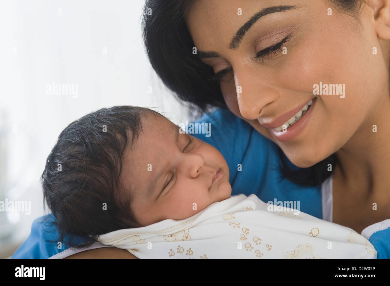 Woman carrying her baby Stock Photo - Alamy