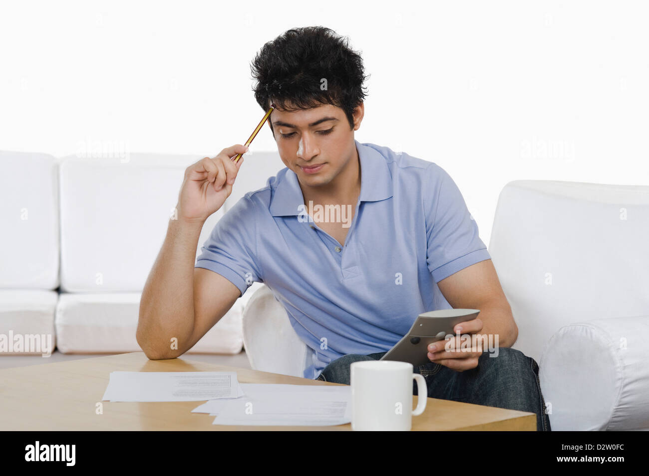 Man doing paperwork at home Stock Photo - Alamy