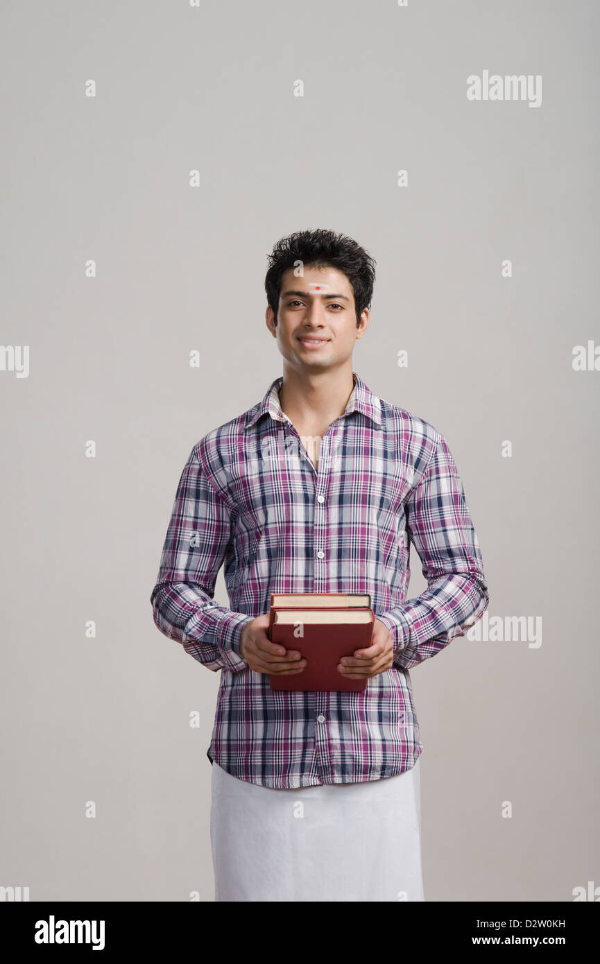 Portrait of an university student holding books Stock Photo - Alamy