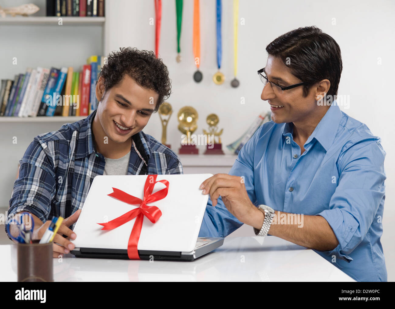 Man gifting a laptop to his son Stock Photo - Alamy