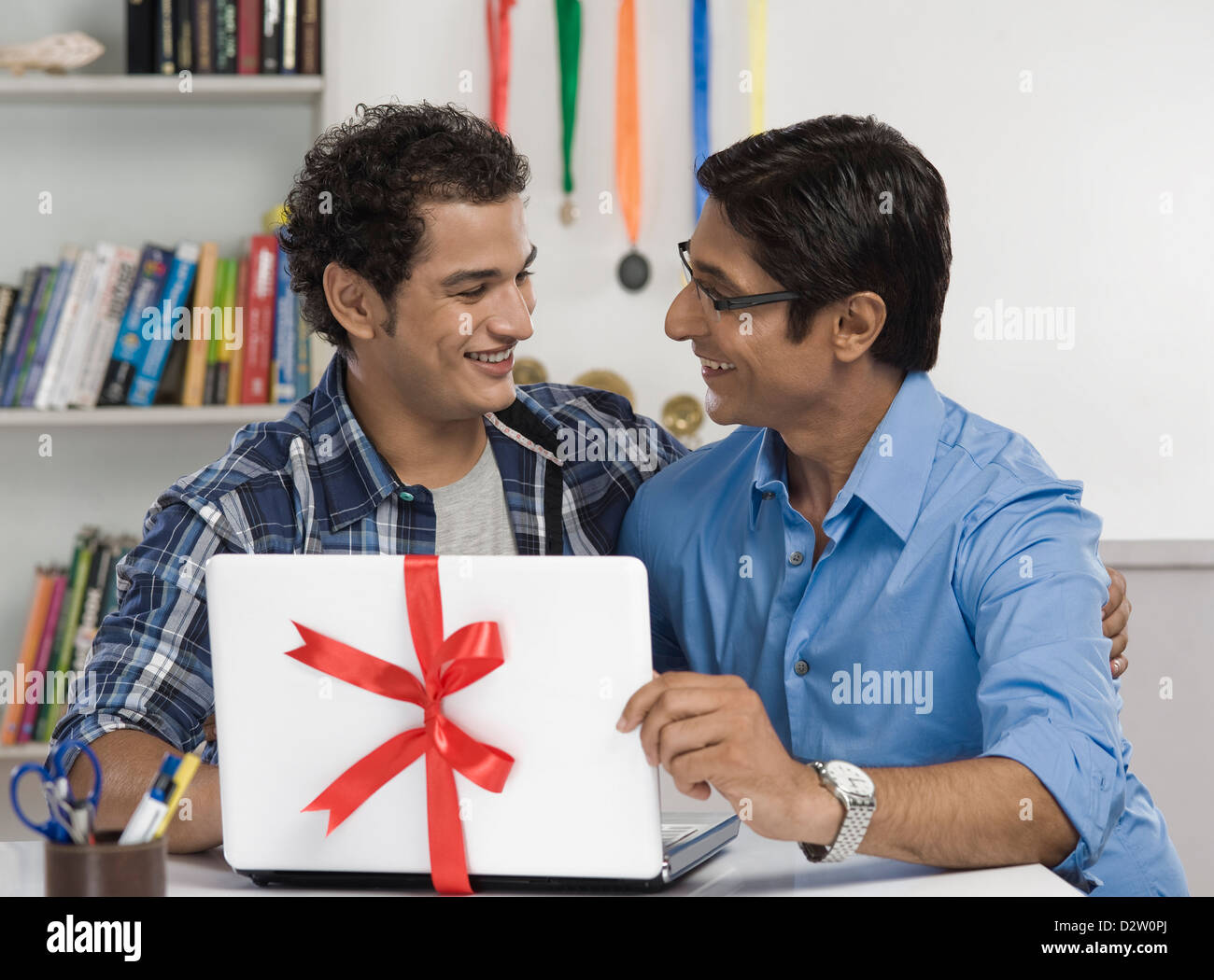 Man gifting a laptop to his son Stock Photo - Alamy