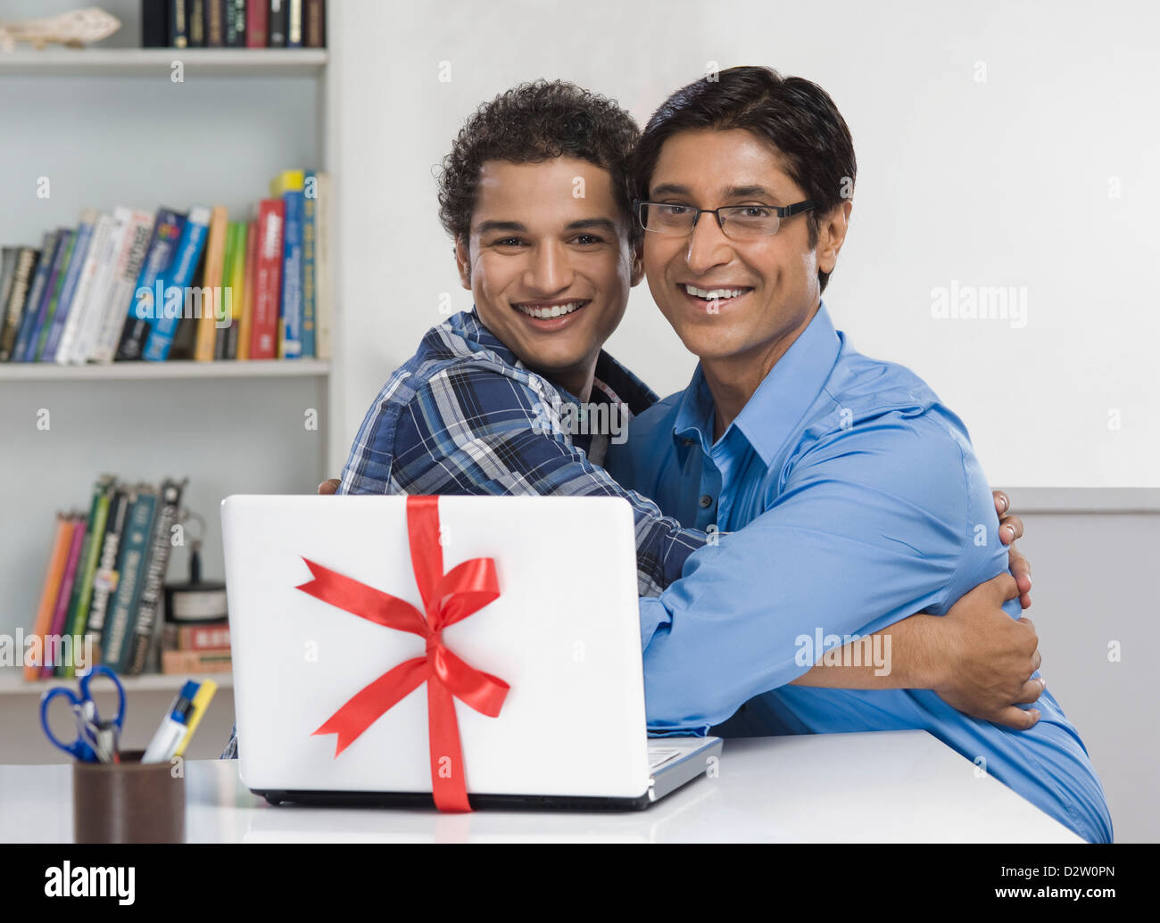 Portrait of a man and his son hugging each other Stock Photo - Alamy
