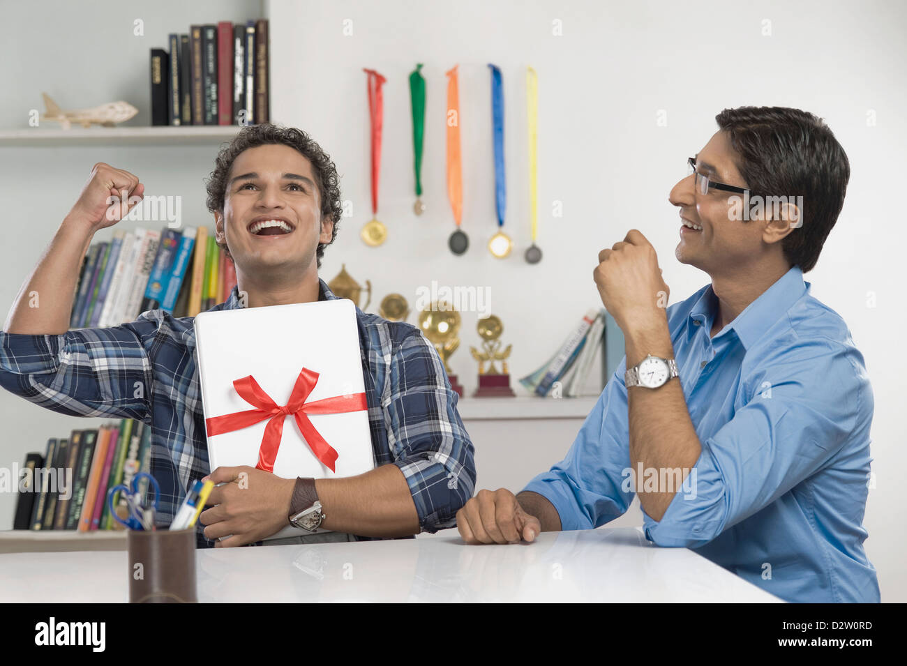 Man hugging a laptop and celebrating Stock Photo - Alamy
