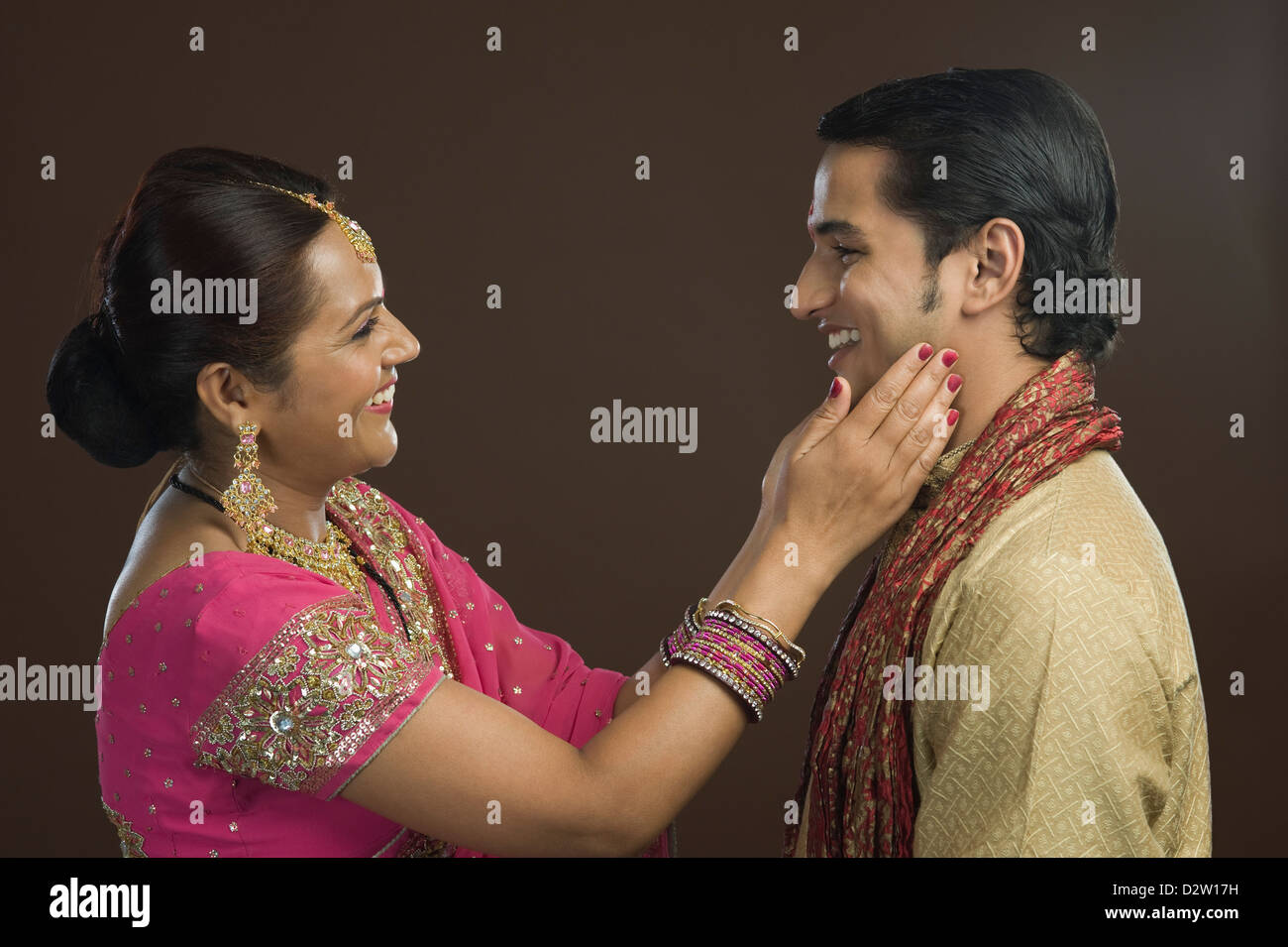 Woman touching cheeks of her son Stock Photo - Alamy