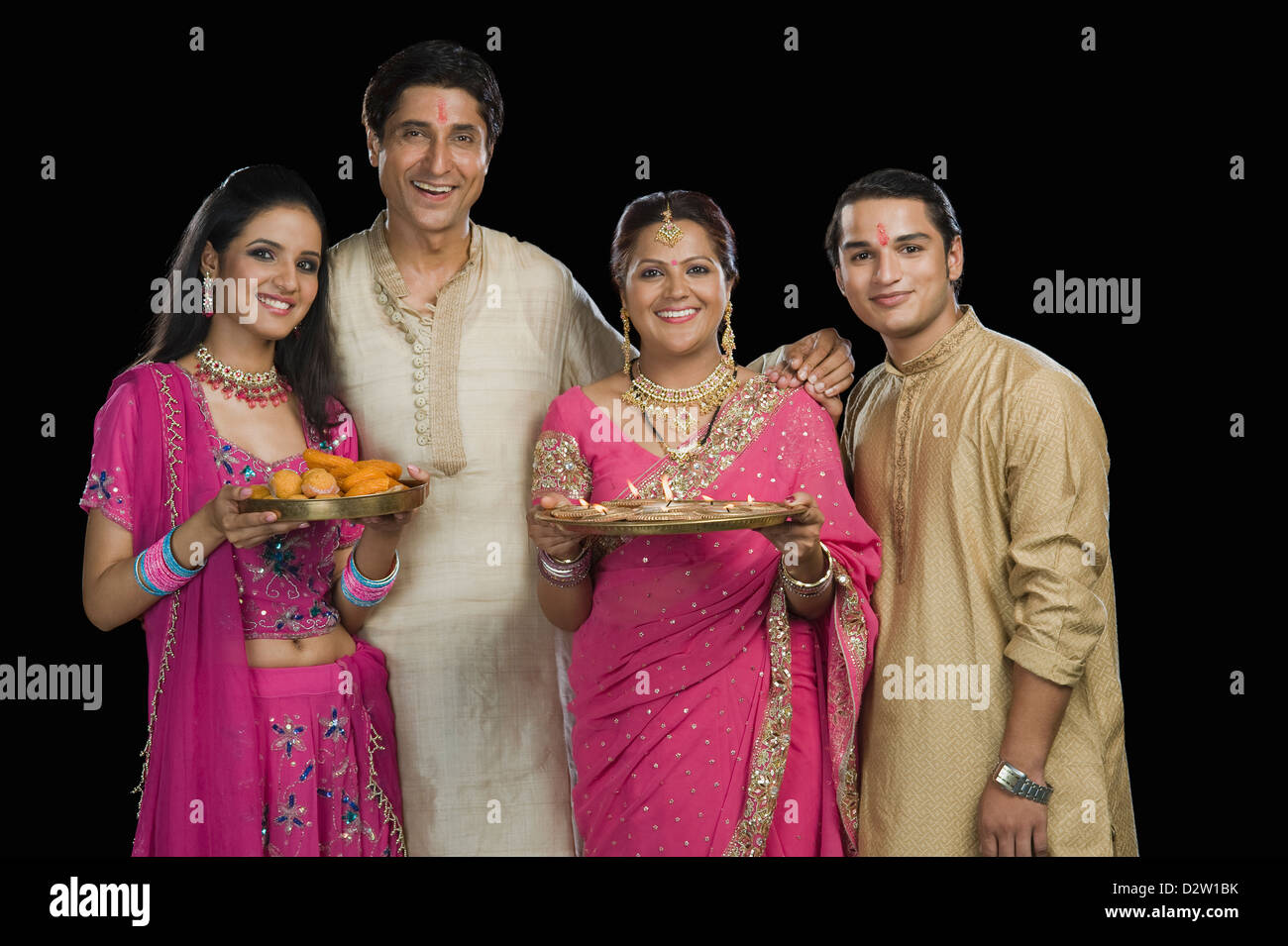 Portrait of a family standing in traditional Indian clothing Stock ...