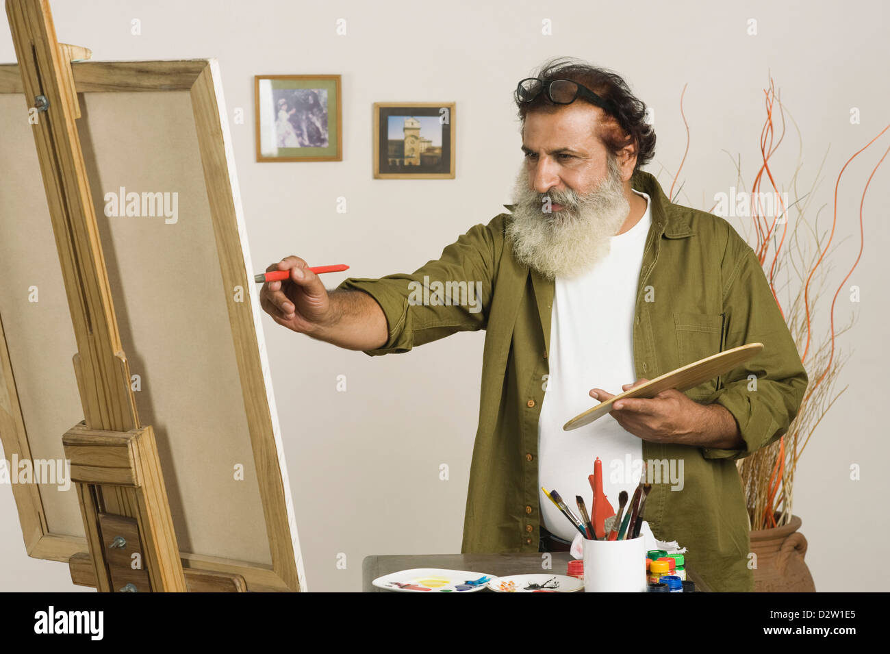 Artist painting on a canvas Stock Photo - Alamy