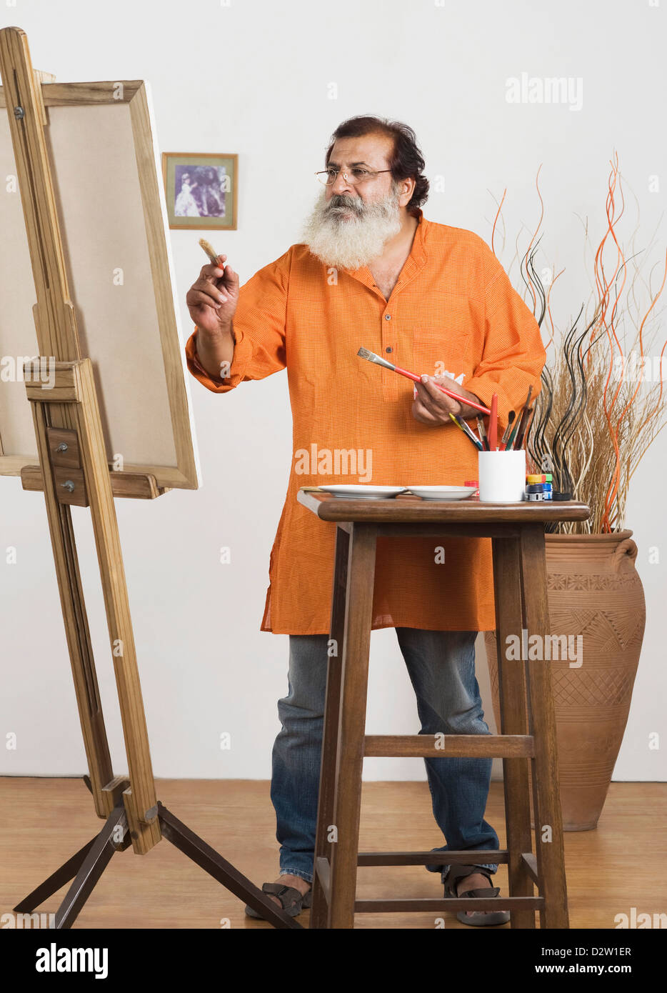 Man painting on a canvas Stock Photo - Alamy