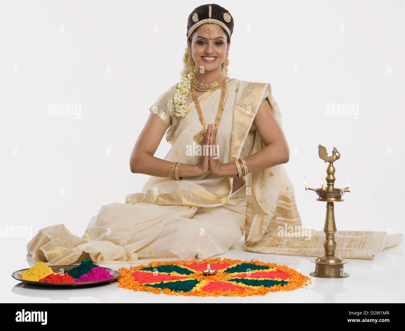 Indian woman in traditional clothing praying at Durga puja festival ...
