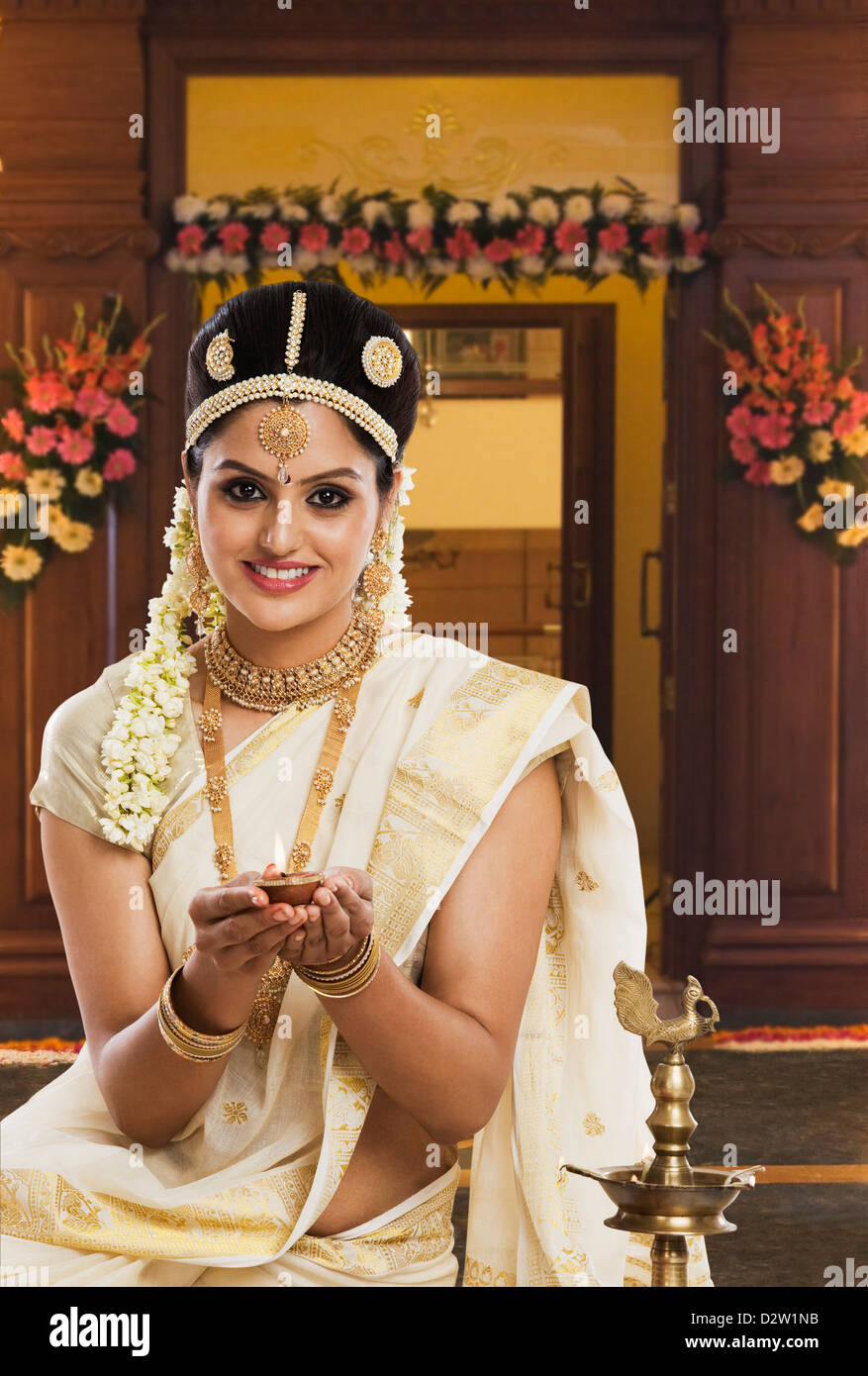 Indian woman in traditional clothing praying with an oil lamp Stock ...